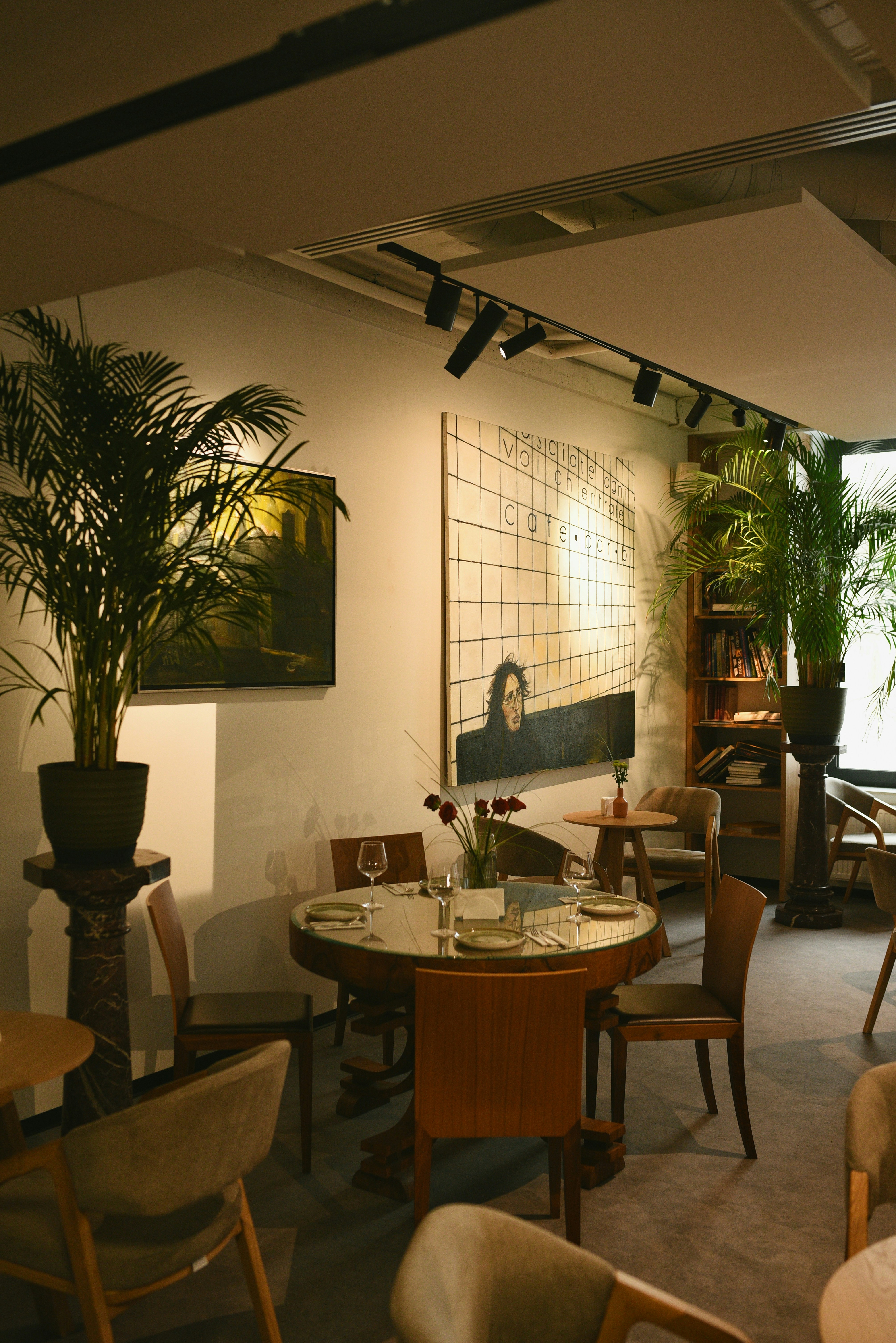Chic Café Corner with Round Table Under Gallery Lighting
