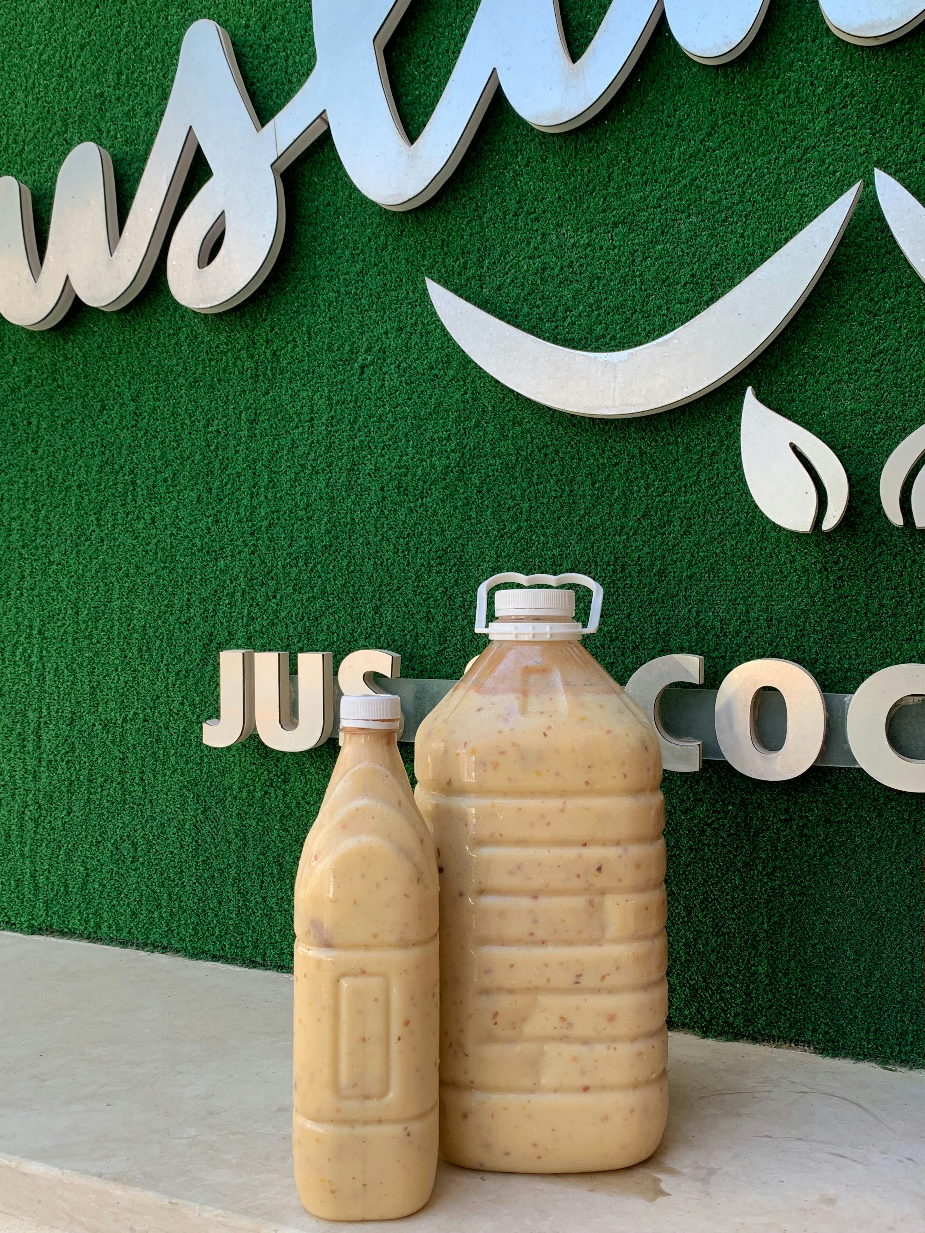 Carafe and Bottle Duo before a Green Wall Signage