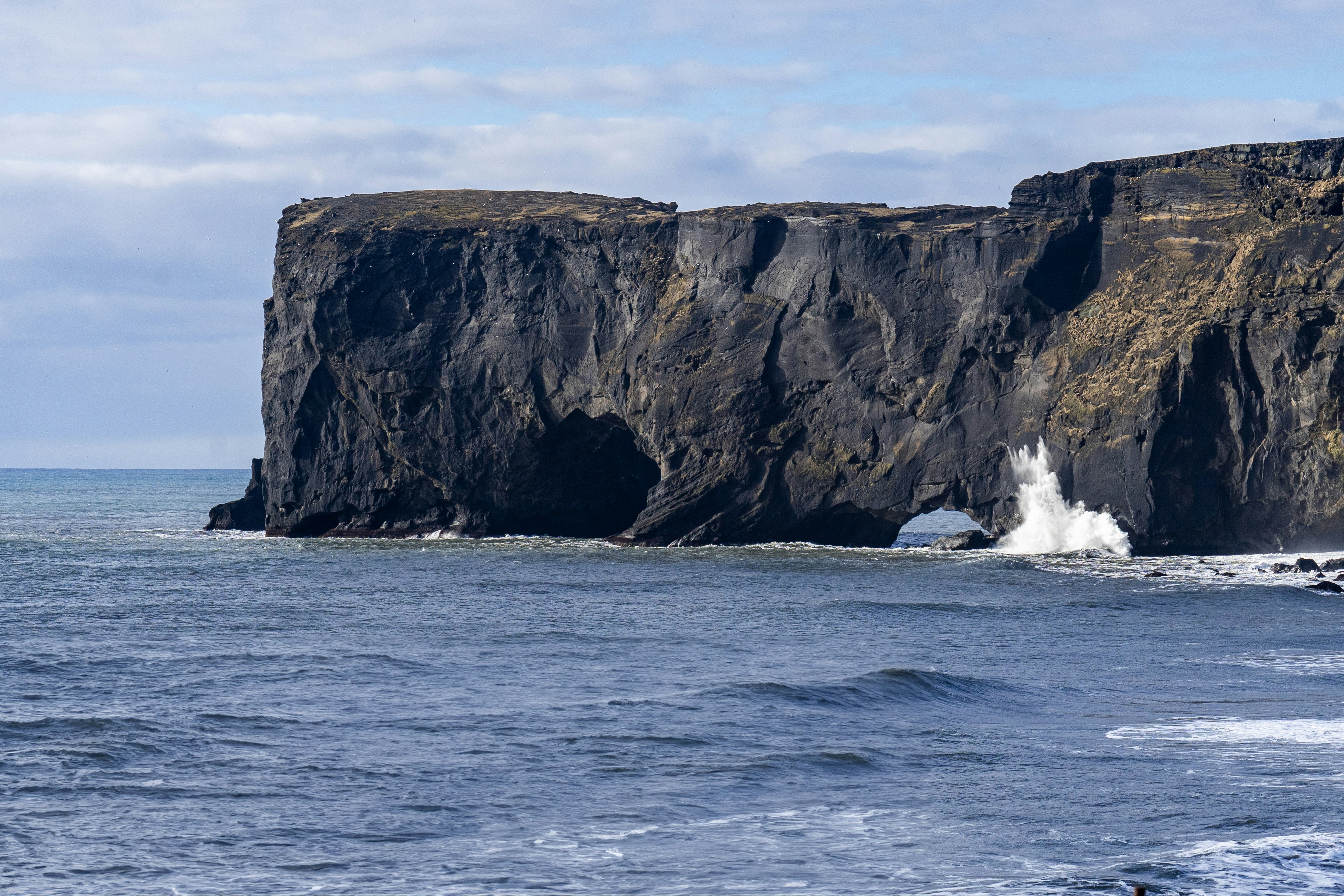 Stormy Sea Meets Dark Cliff: A Coastal Portrait