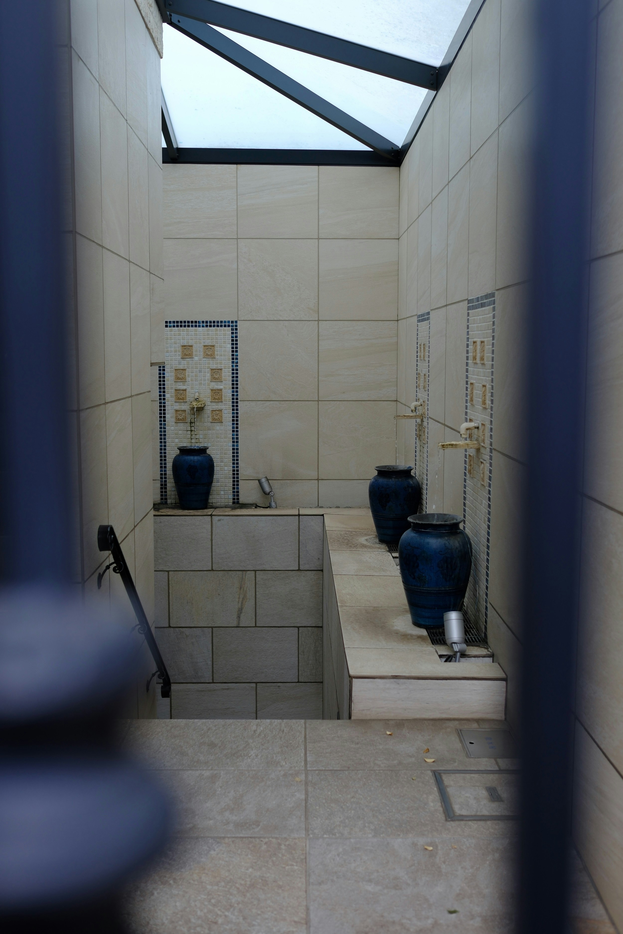 Blue Vessels in a Walled Waterfall Corridor