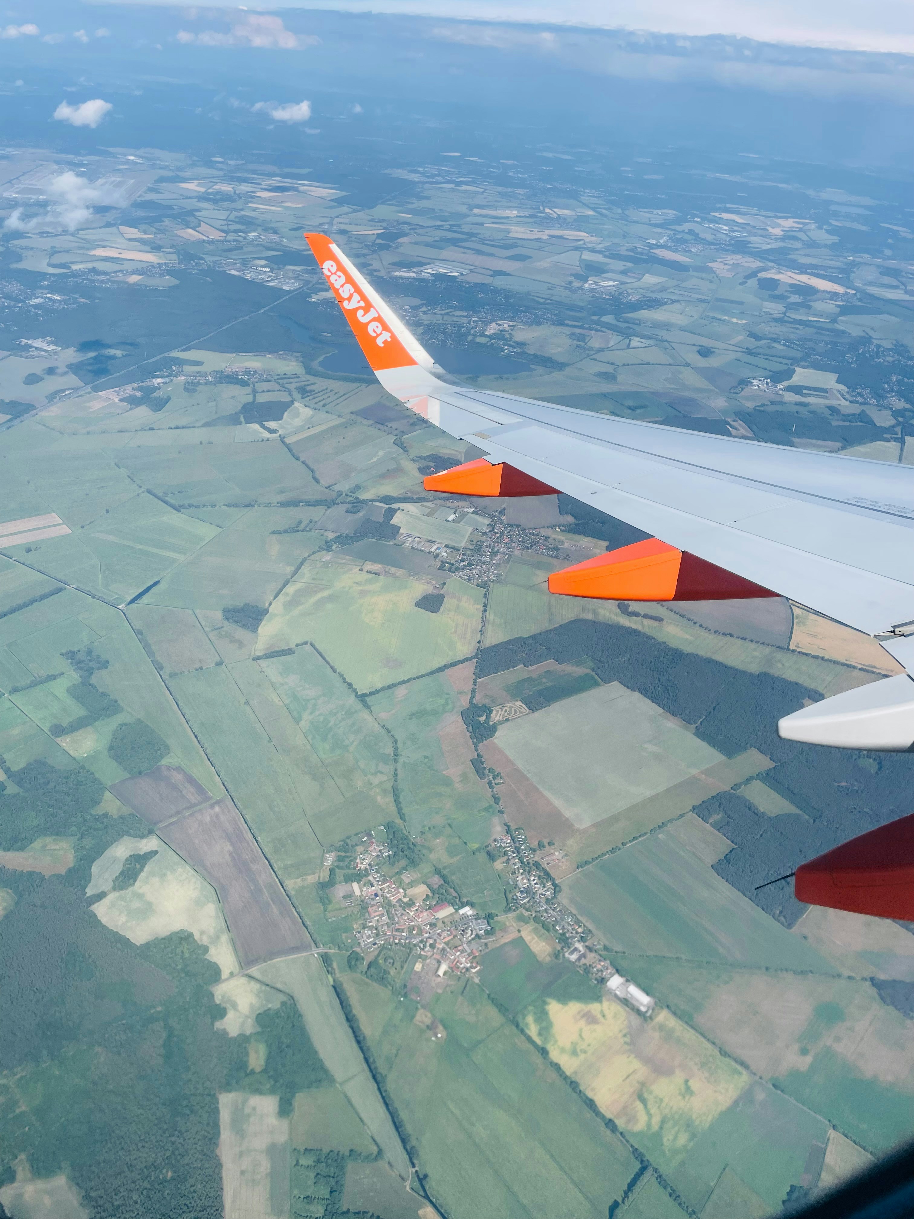 Wing Vista: Concrete Patchwork Beneath a Far-Right Horizon