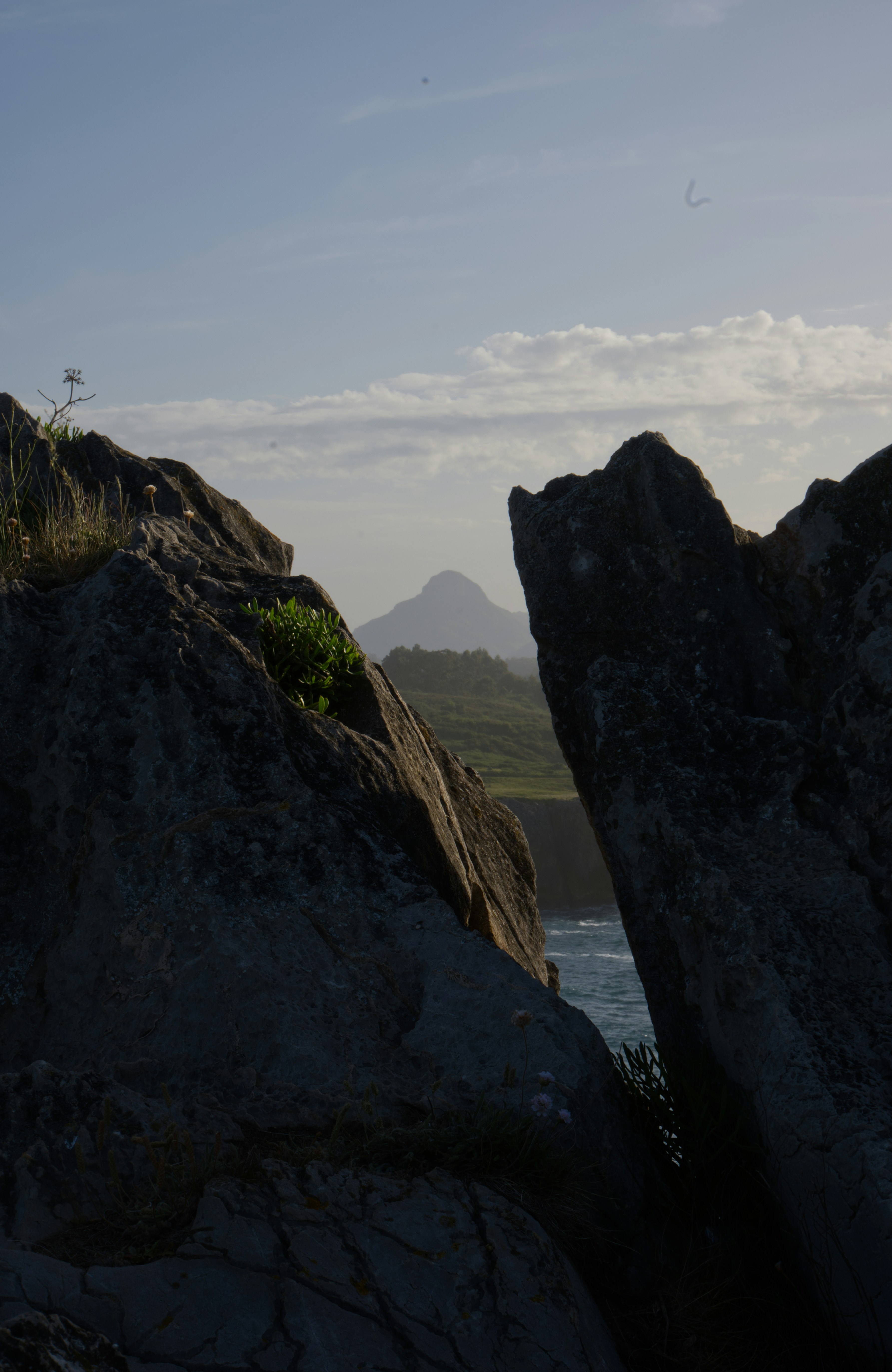 Rugged Rocks Framing a Distant Peak at Sunset