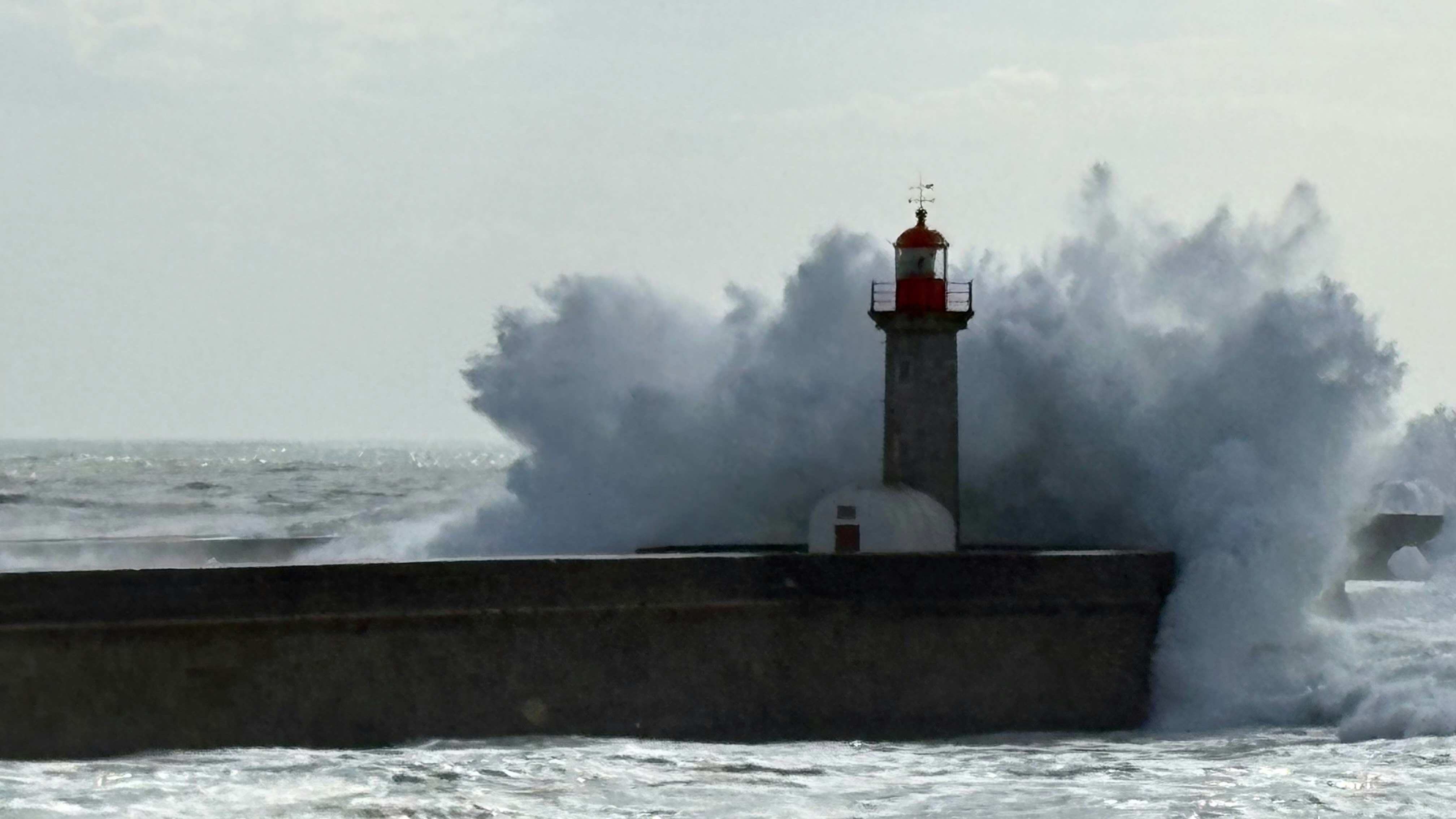 Lighthouse Standoff:Wave Break at the Breakwall
