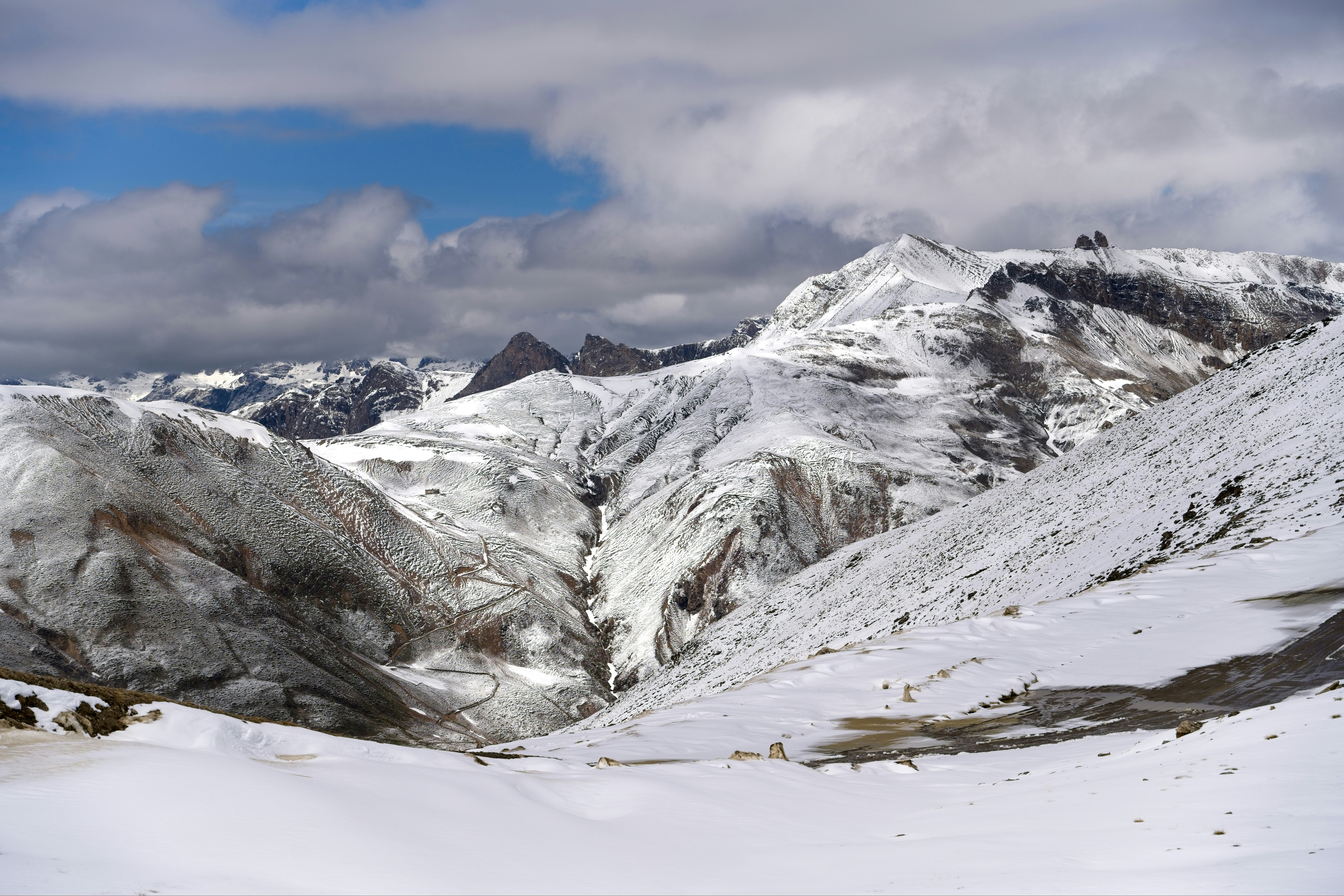 Snowbound Ridge Under a Break in Clouds
