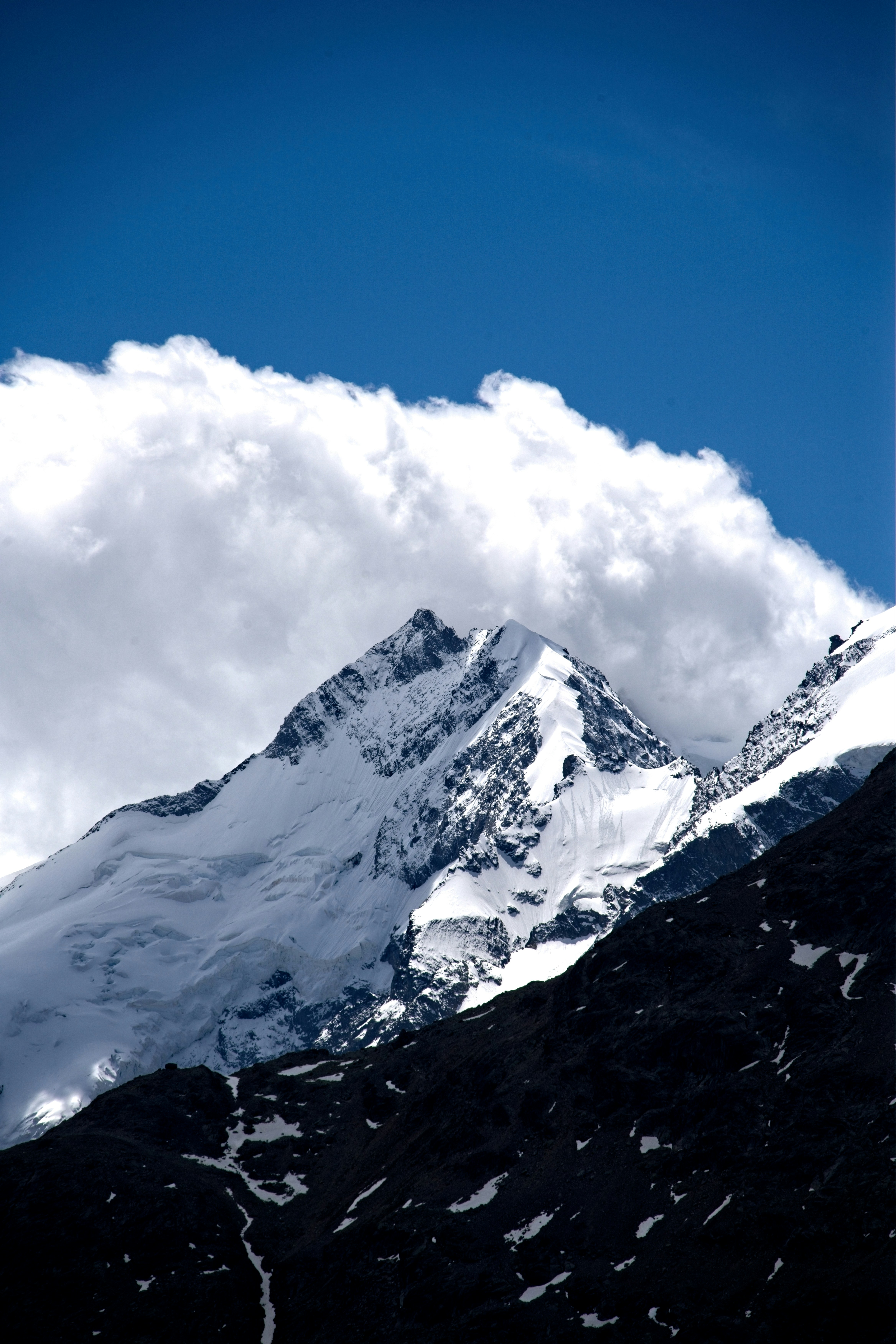 Snow-Crowned Summit Pierced by Blue Void