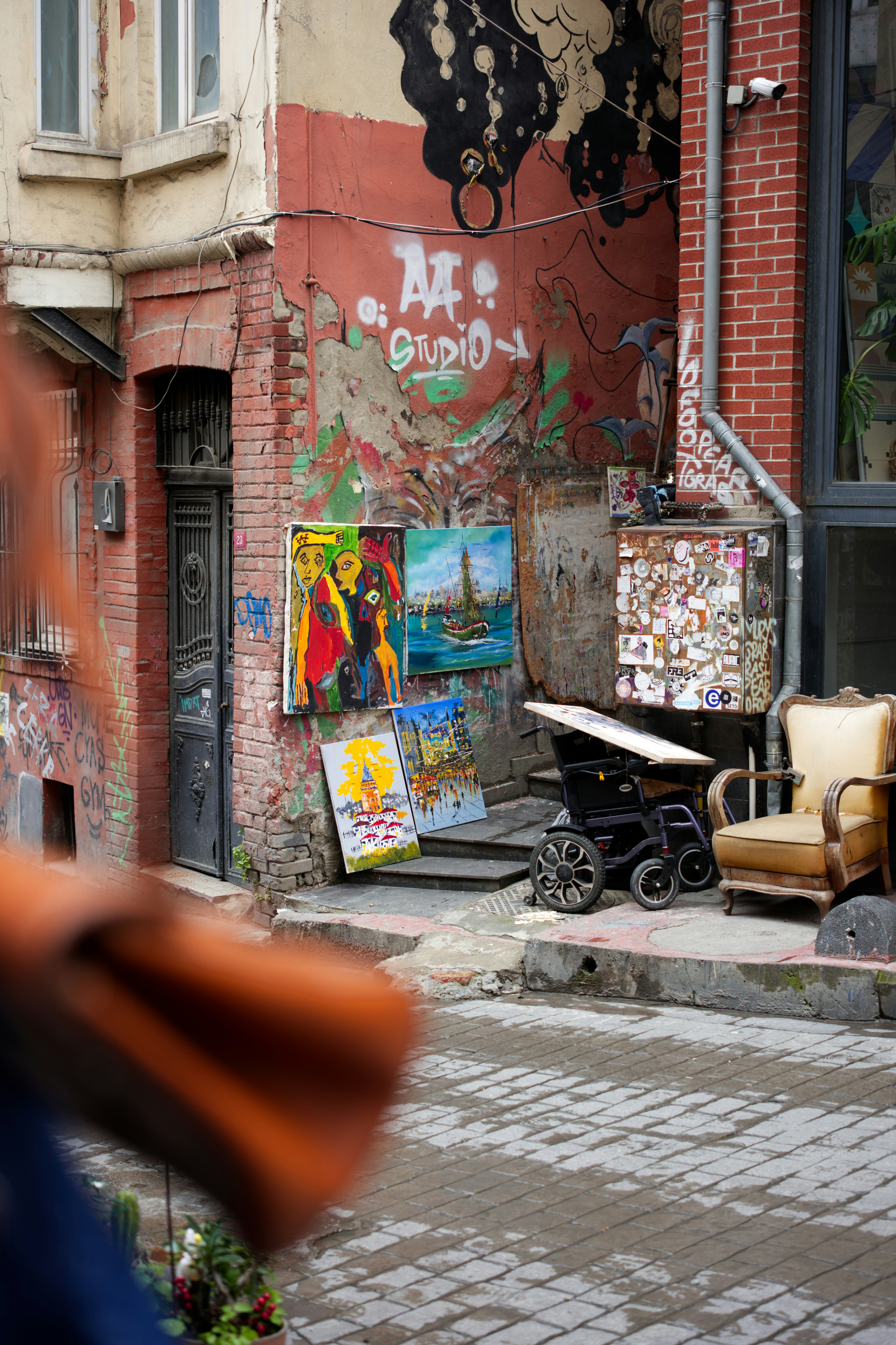 Urban Studio Still Life: Paints, Posters, and a Television Chair