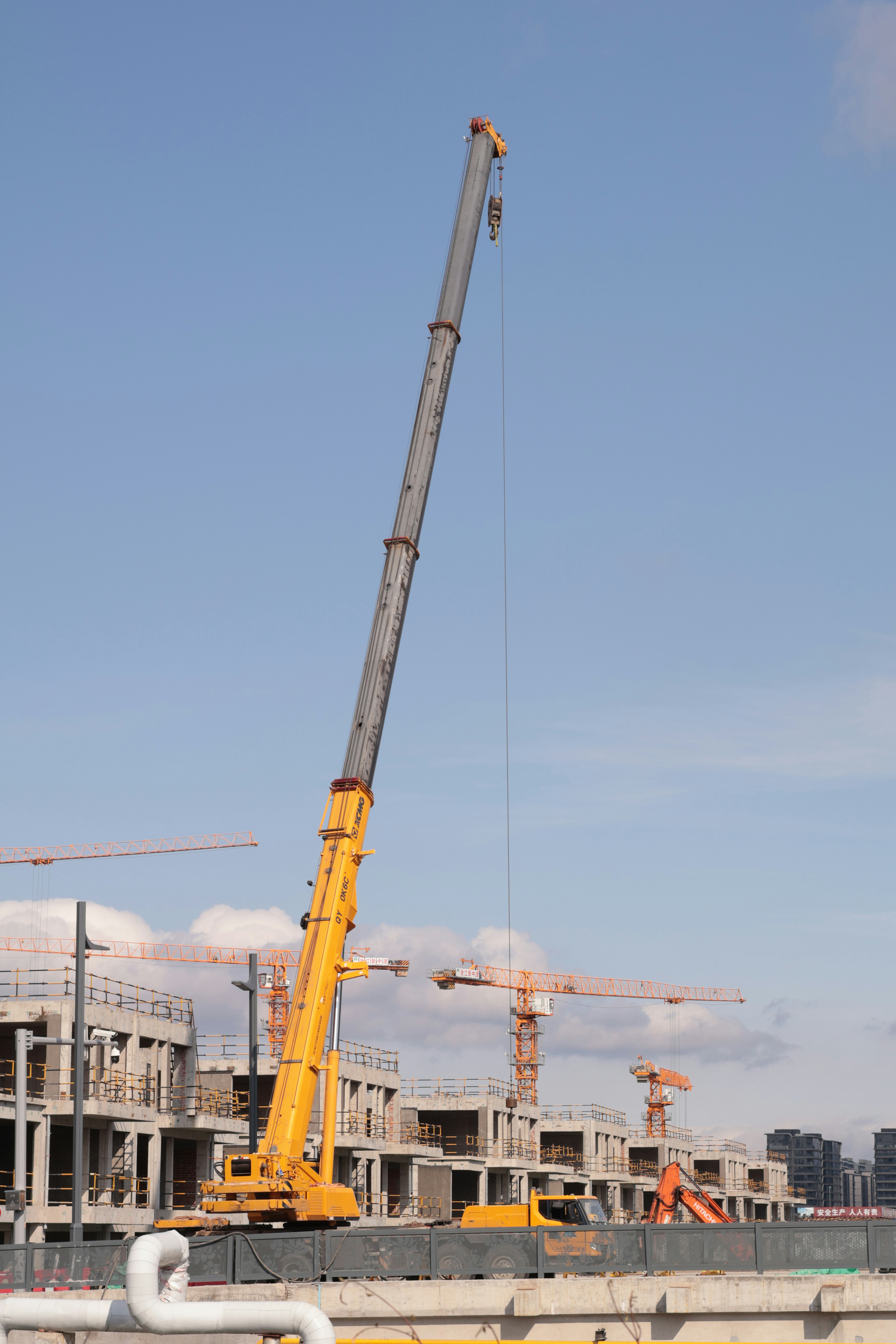Towering Crane Ascending Over a Developing Skyline