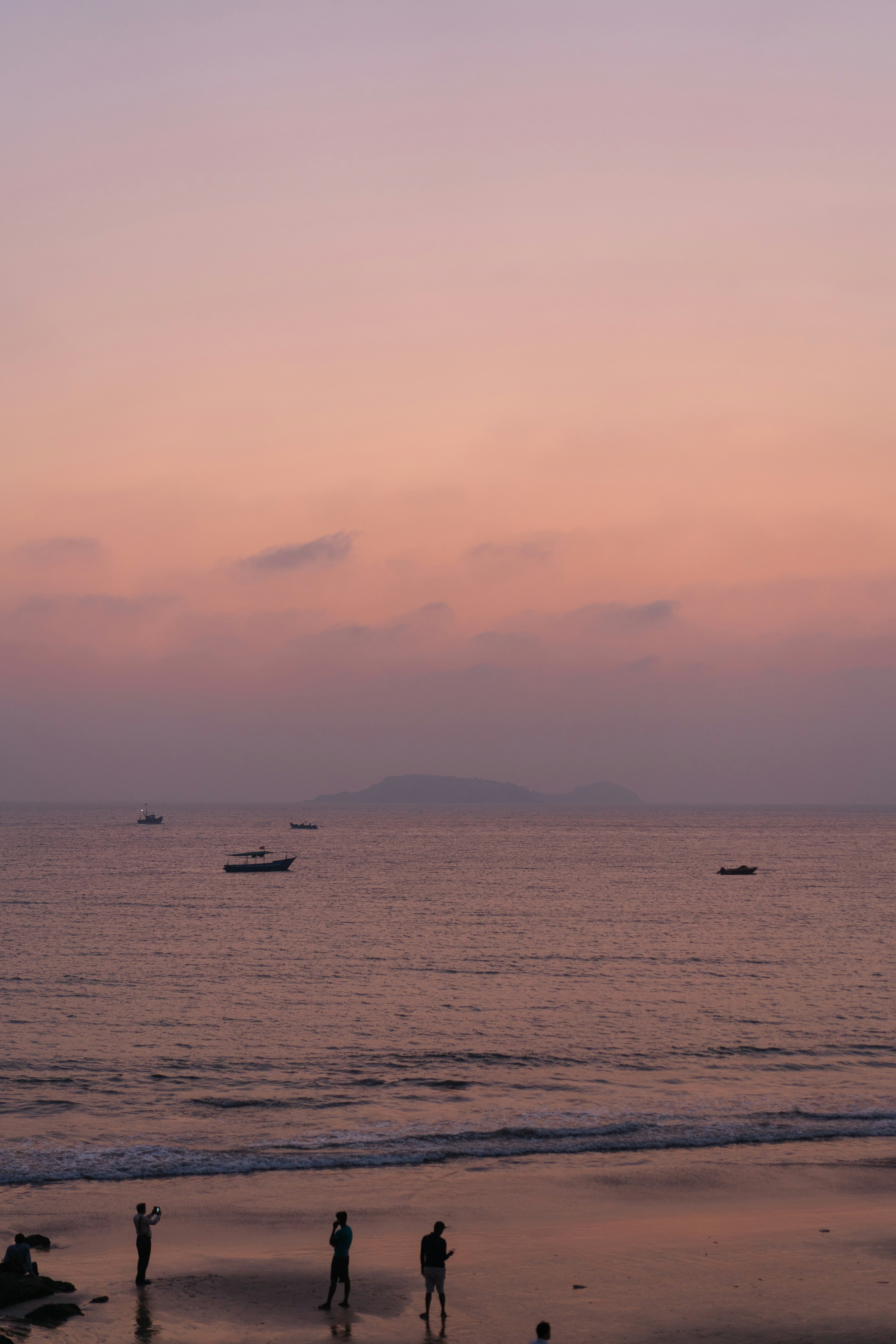 Sunset Silhouettes Over a Quiet Sea