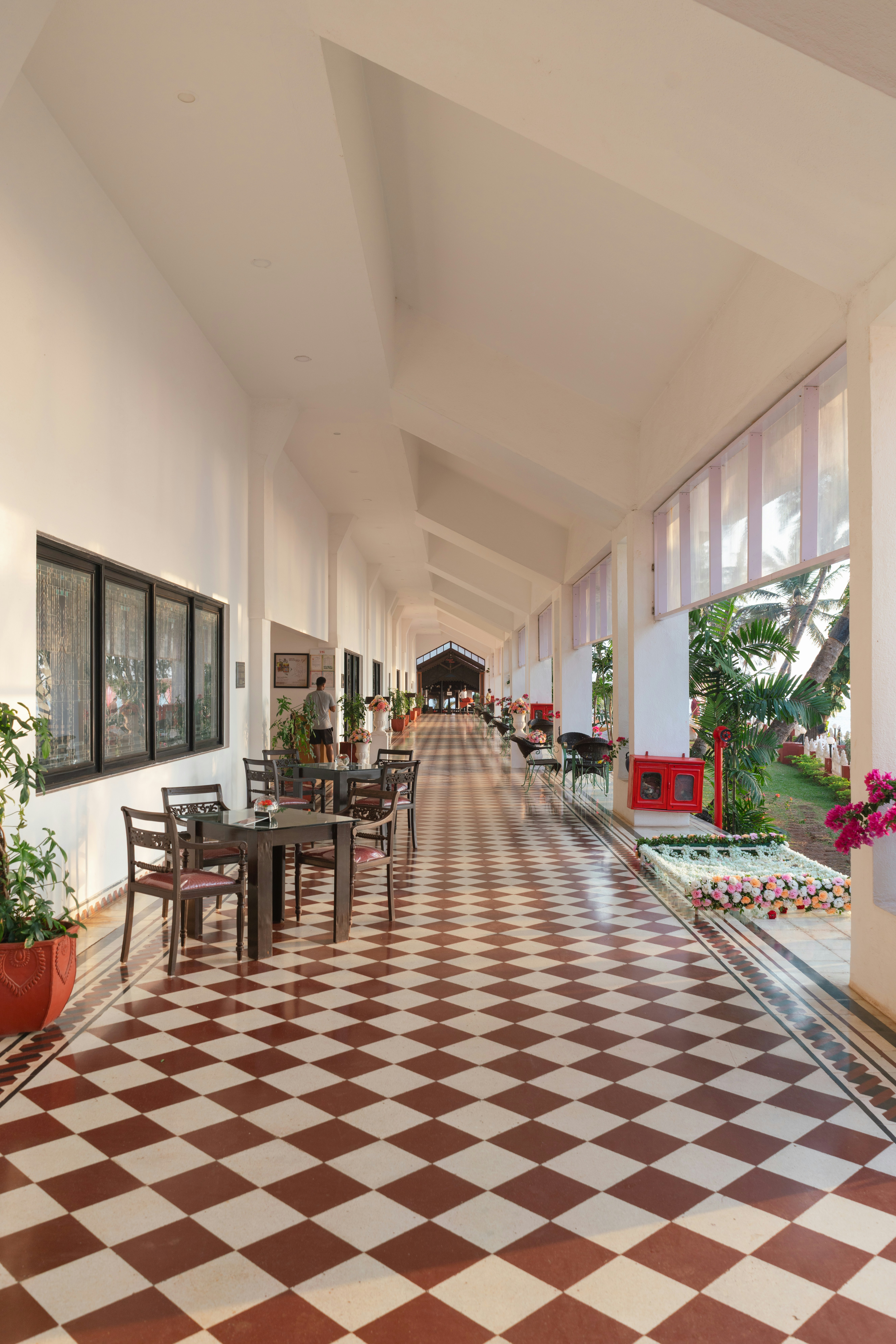 Sunlit Corridor of Columns and Checkered Tiles