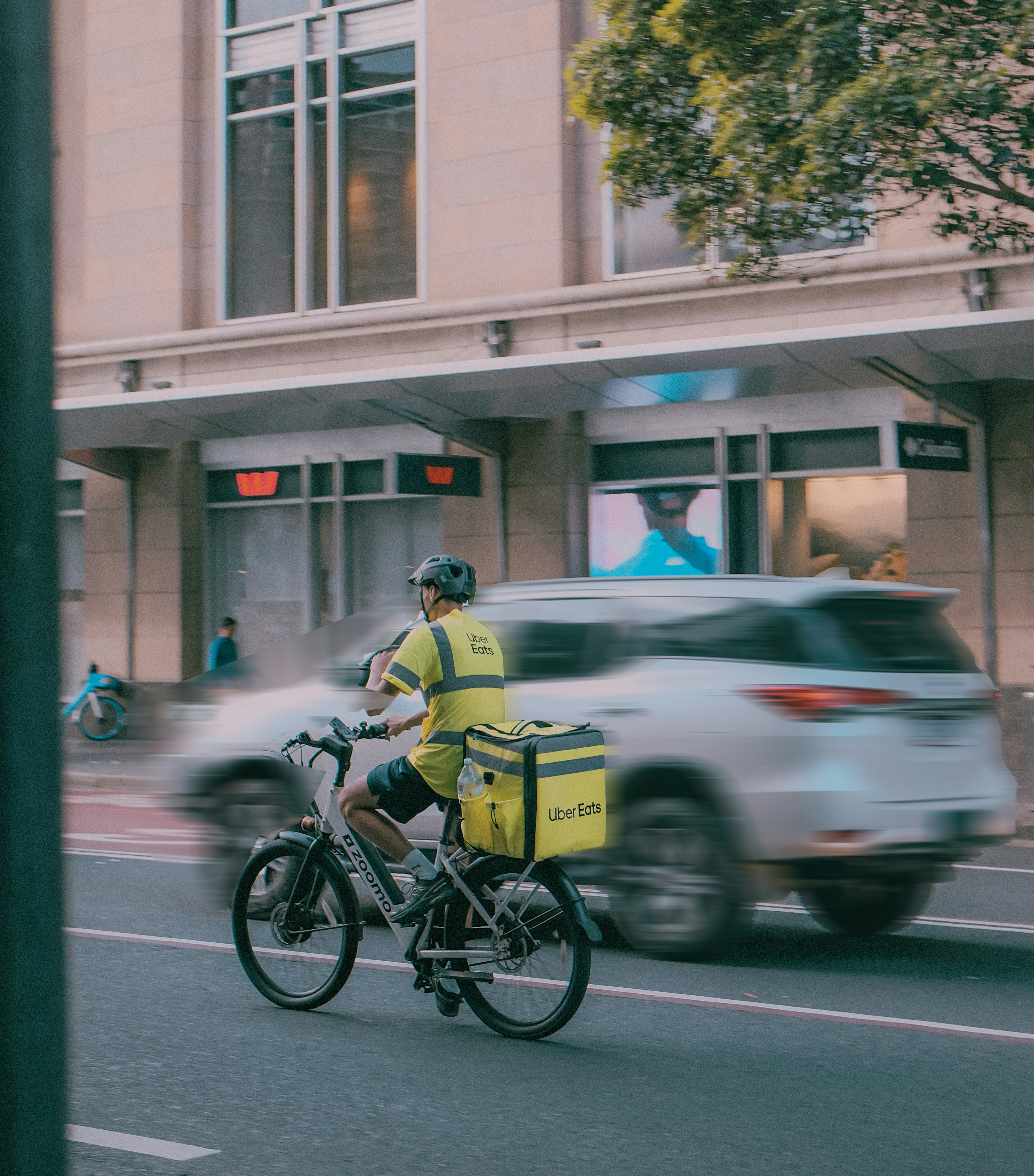 Urban Courier in Motion: A Yellow-Eyed Ride Through the Street