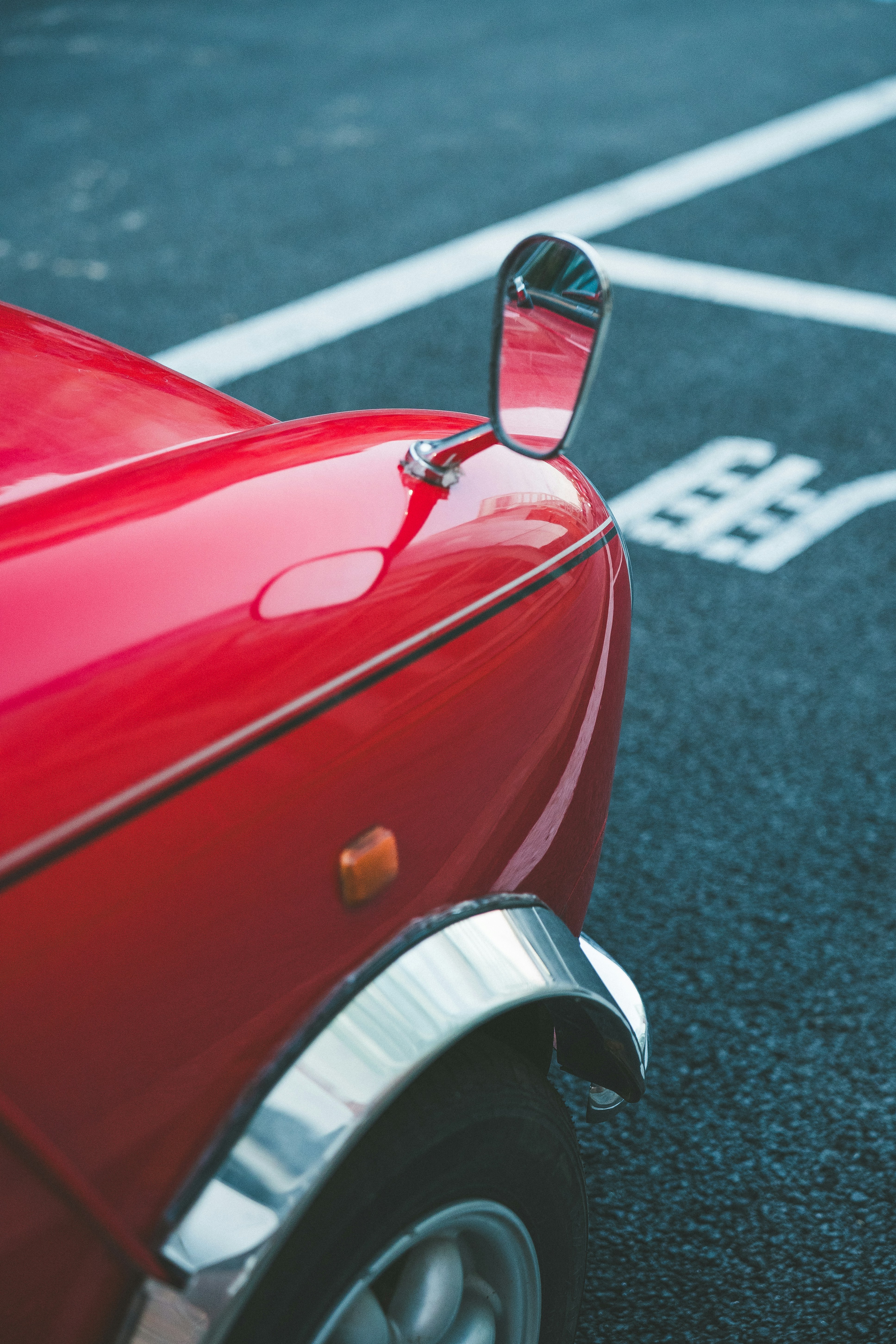 Red Vintage Car Hood Embracing the Parking Lot Line