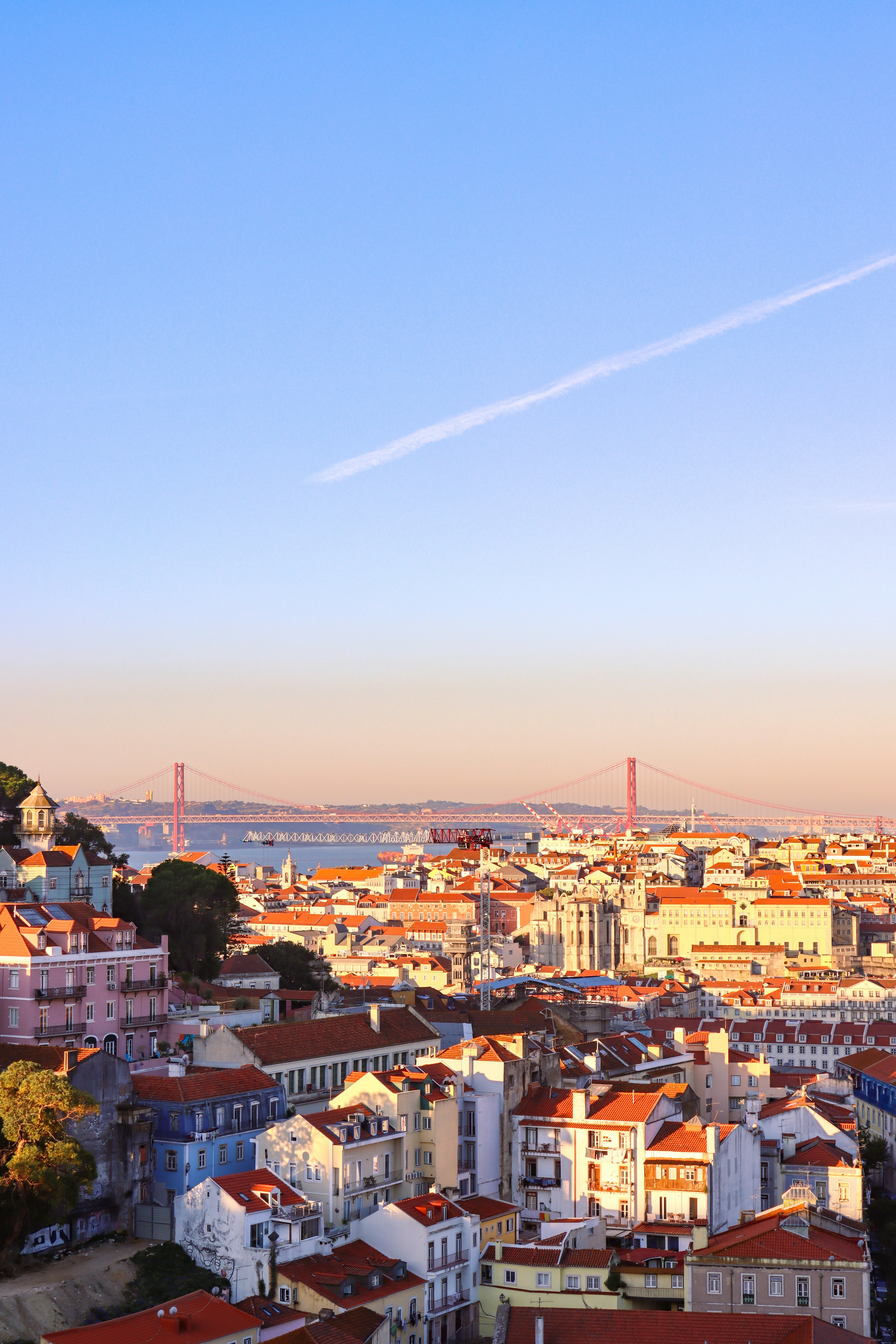 Sunlit Hillside Mosaic: A Golden Hour Panorama Over a Portuguese City