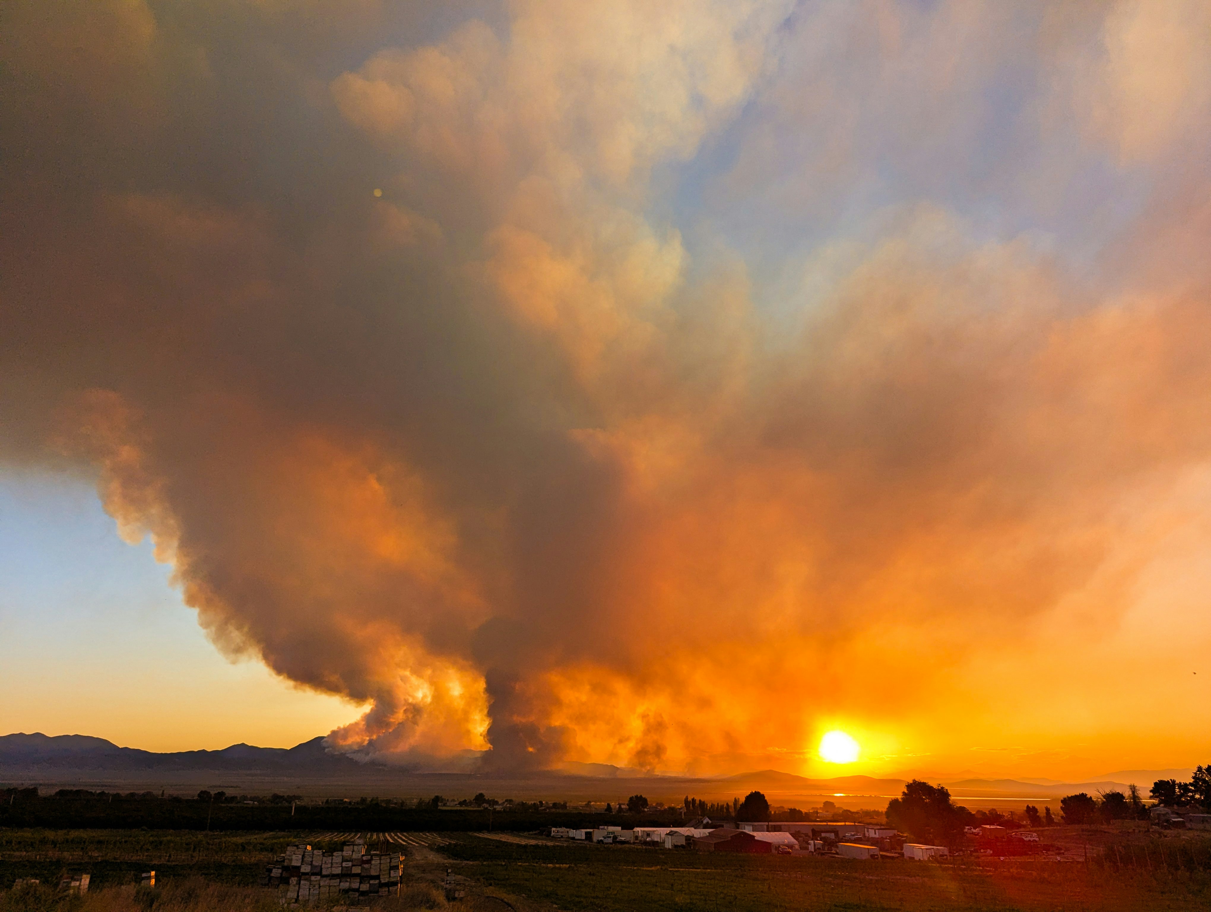 Fiery Horizon: Smoke and Sun Converge at Dusk