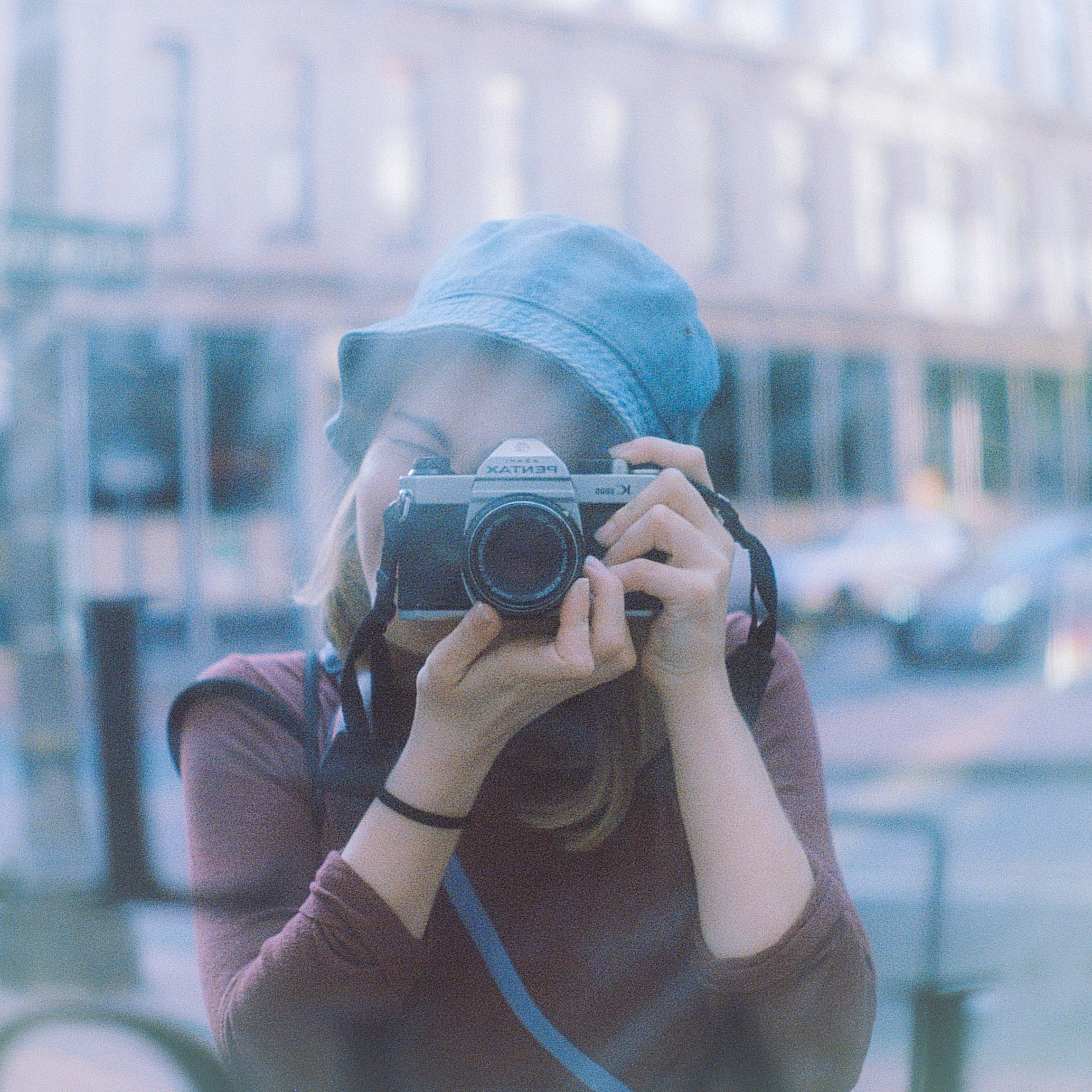 Soft Focus Street Portrait: A Photographer Behind the Lens