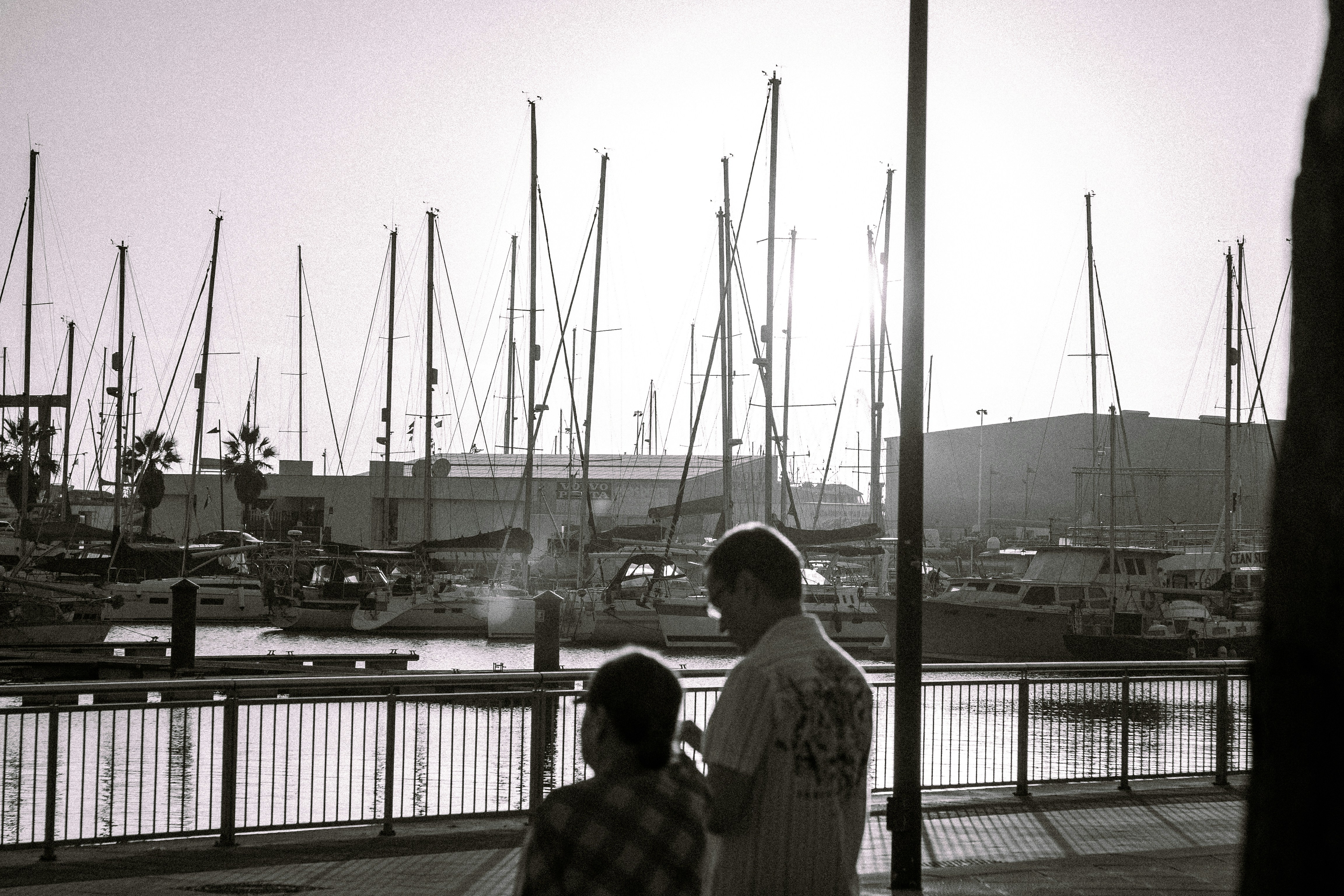Silhouetted Couple Overlook Marina at Dusk