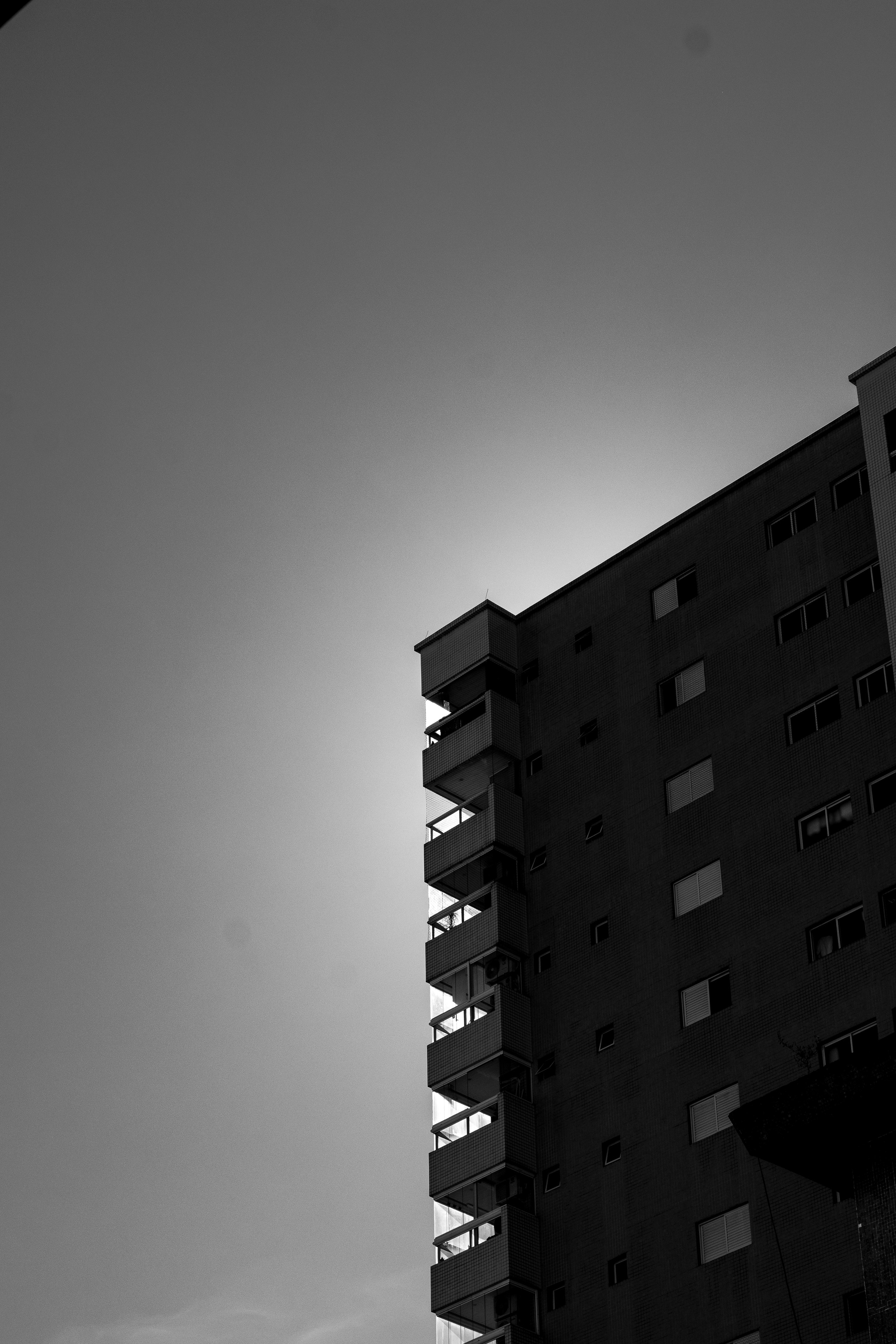 Sunlit Edge: A Silent Balcony Against the City Sky