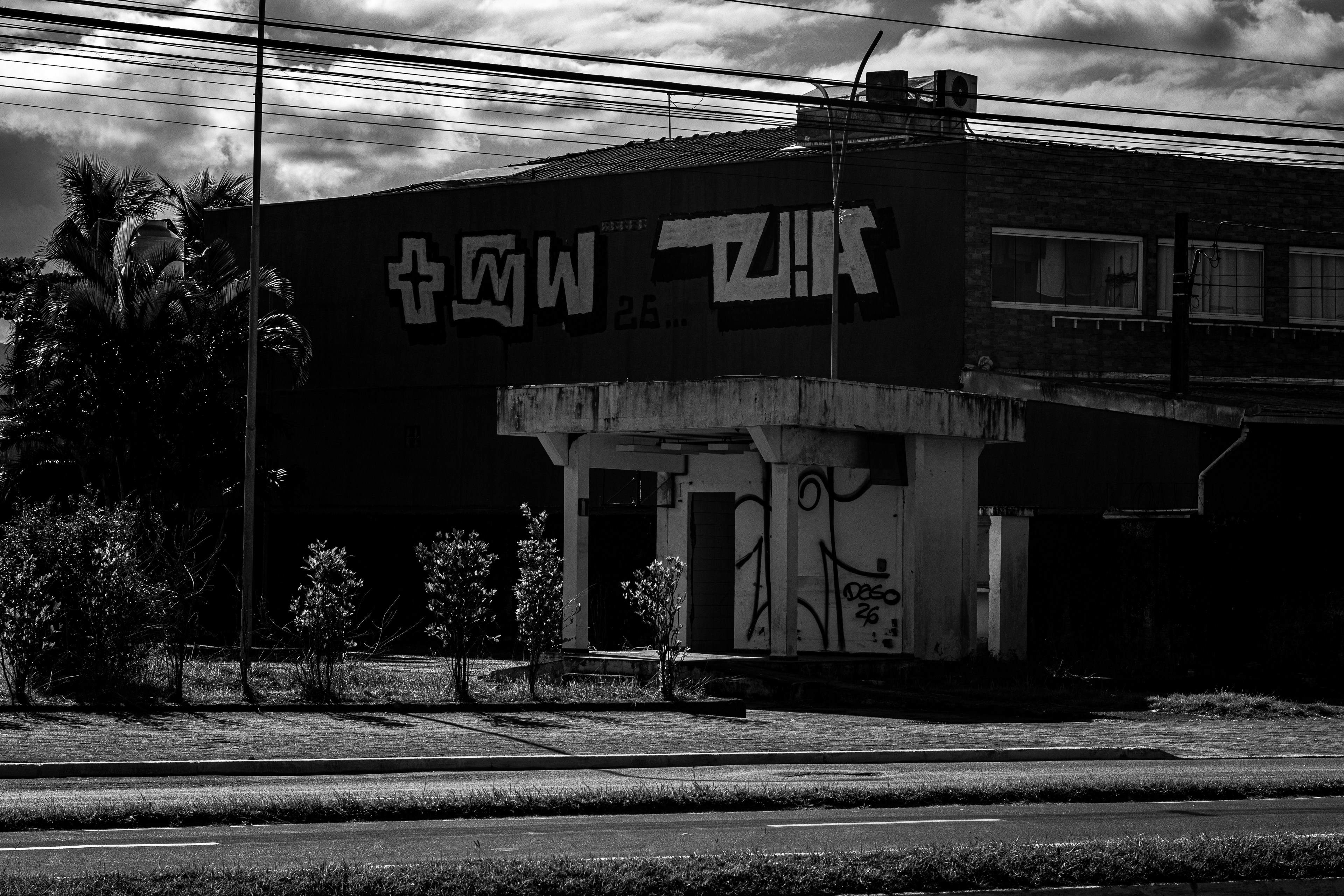 Urban Ghost Signage: A Graffitied Stopover Beneath Power Lines