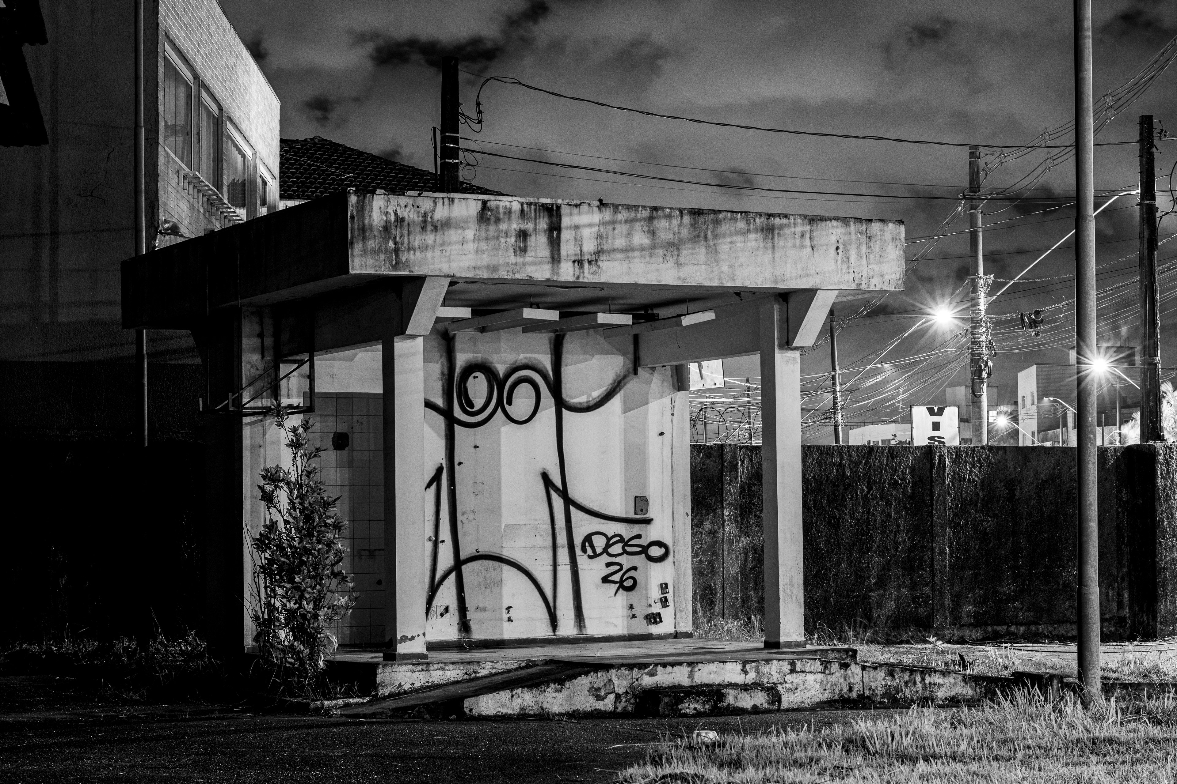 Abandoned Bus Stop in Graffitied Night Scene