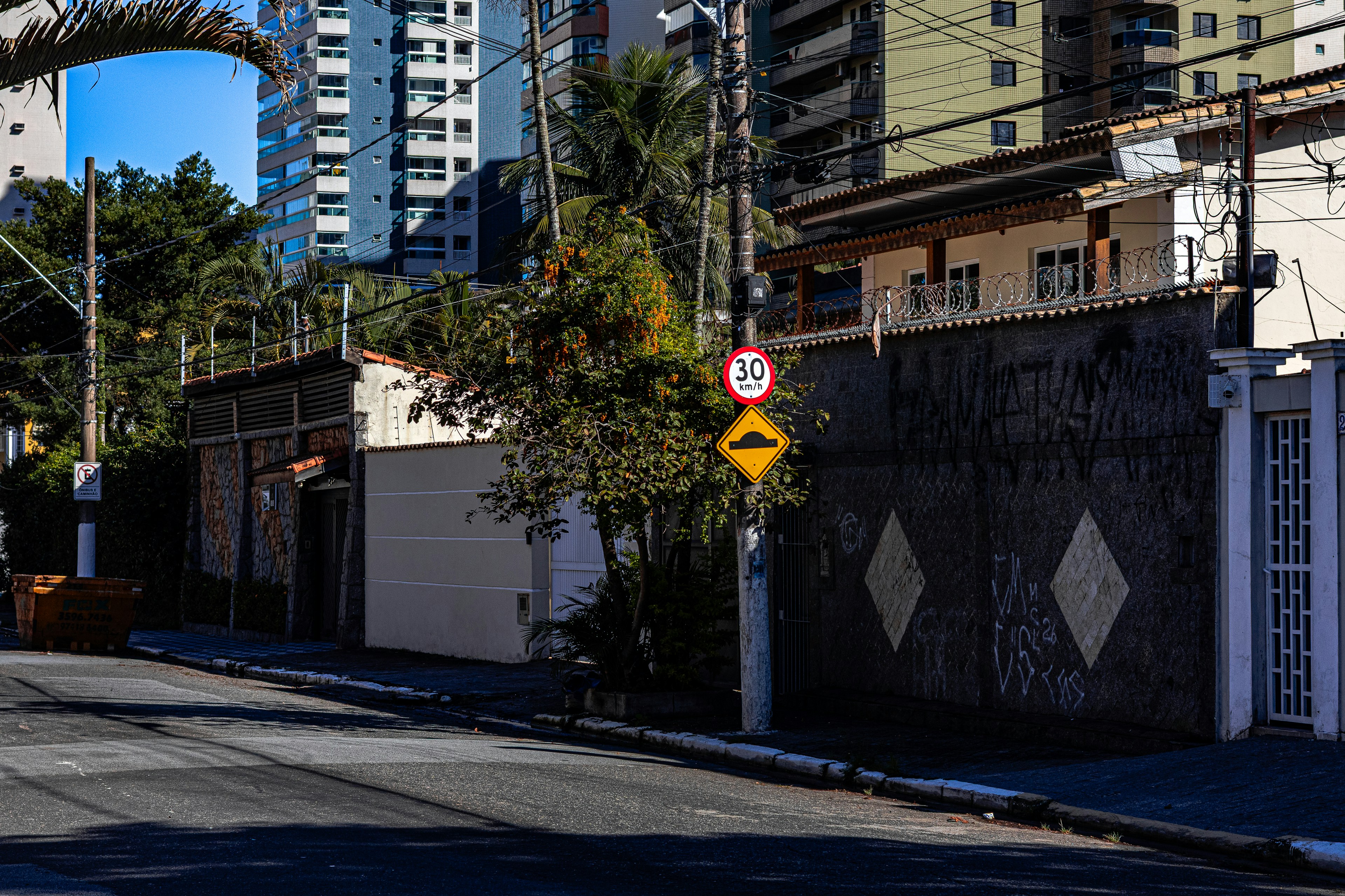 Urban Quiet: Street Corner with Signage and Shadowed Facade