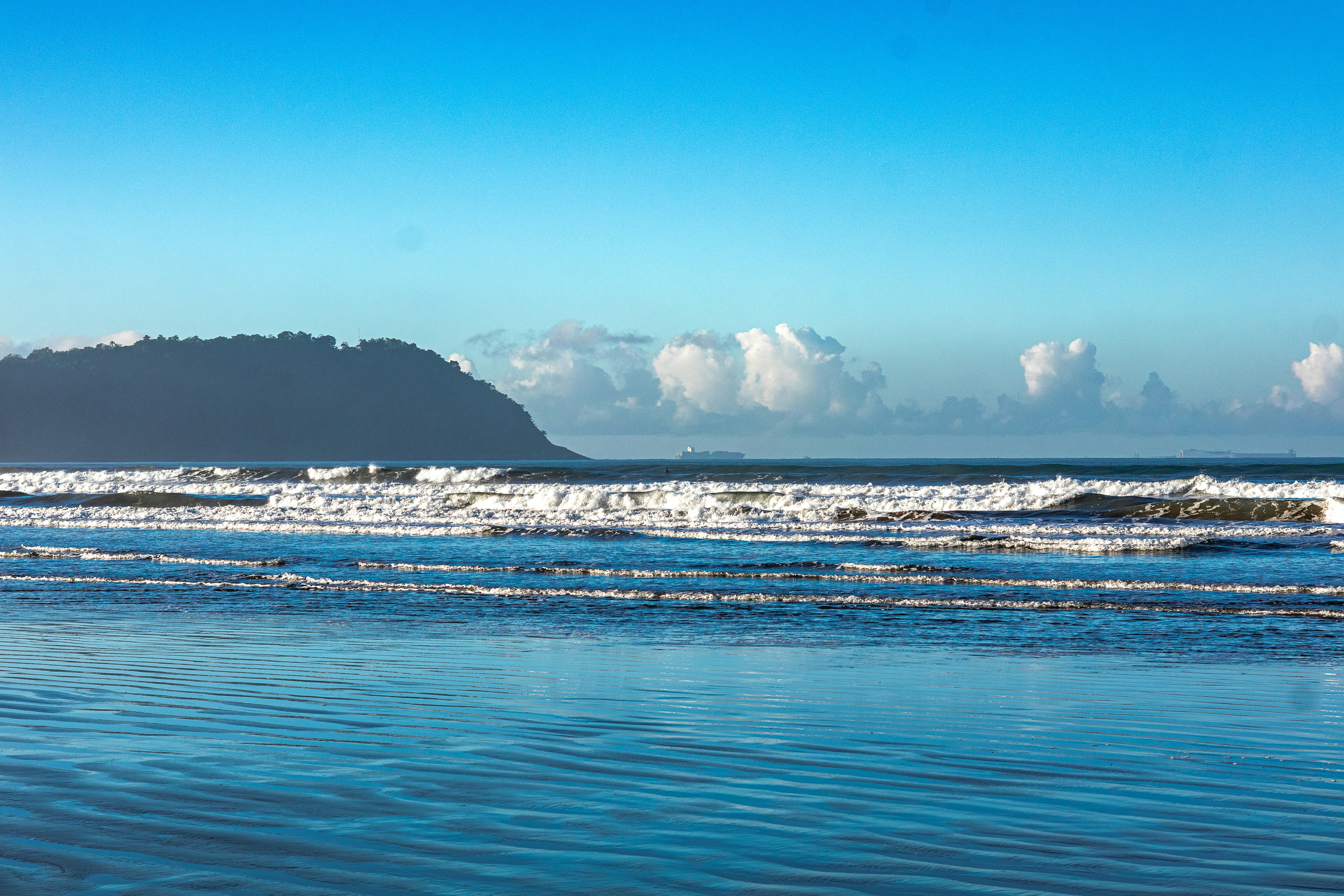 Coastal Silhouette: Ocean Mist Meeting a Distant Headland
