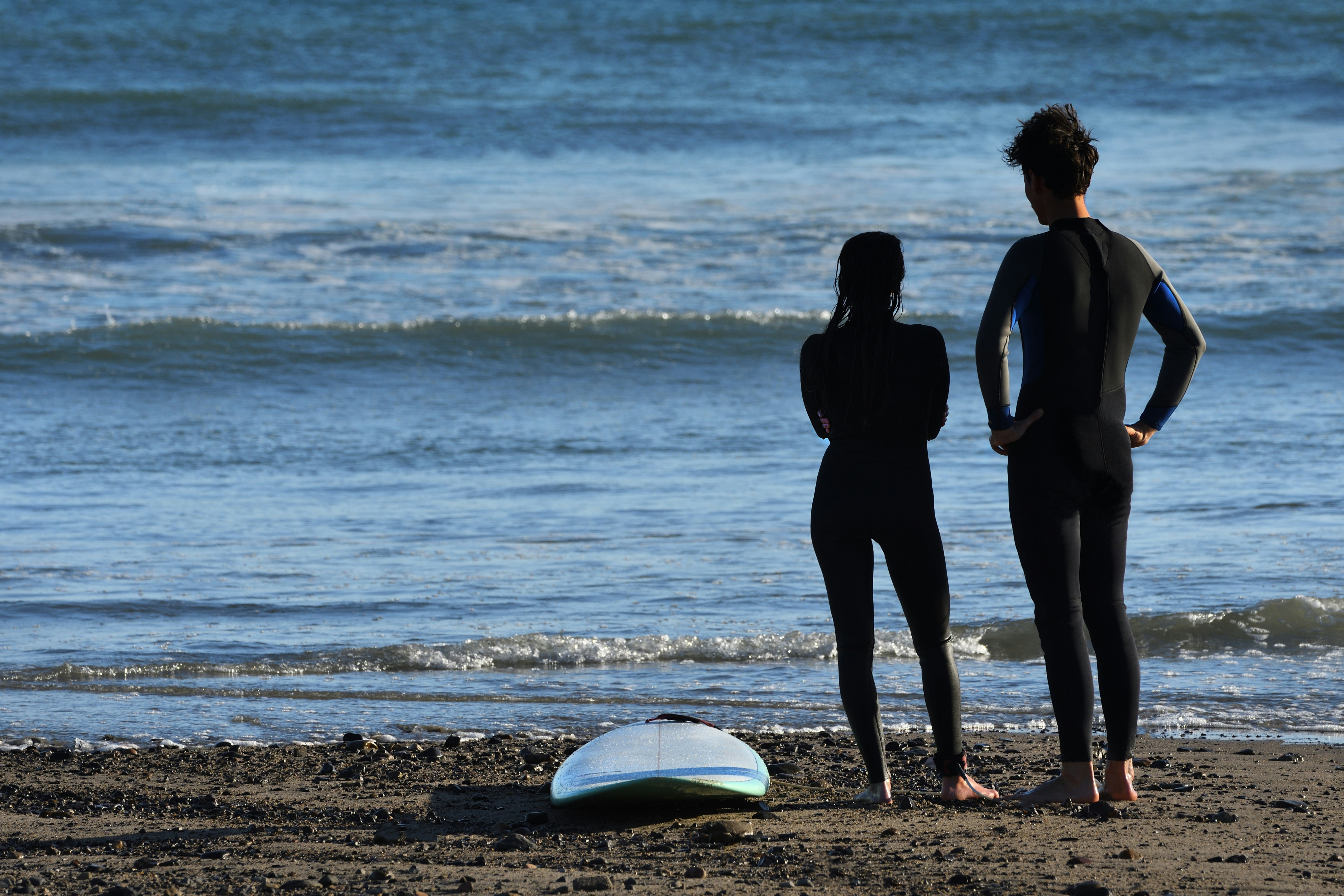 Coastal silhouette: surfers awaiting the next wave