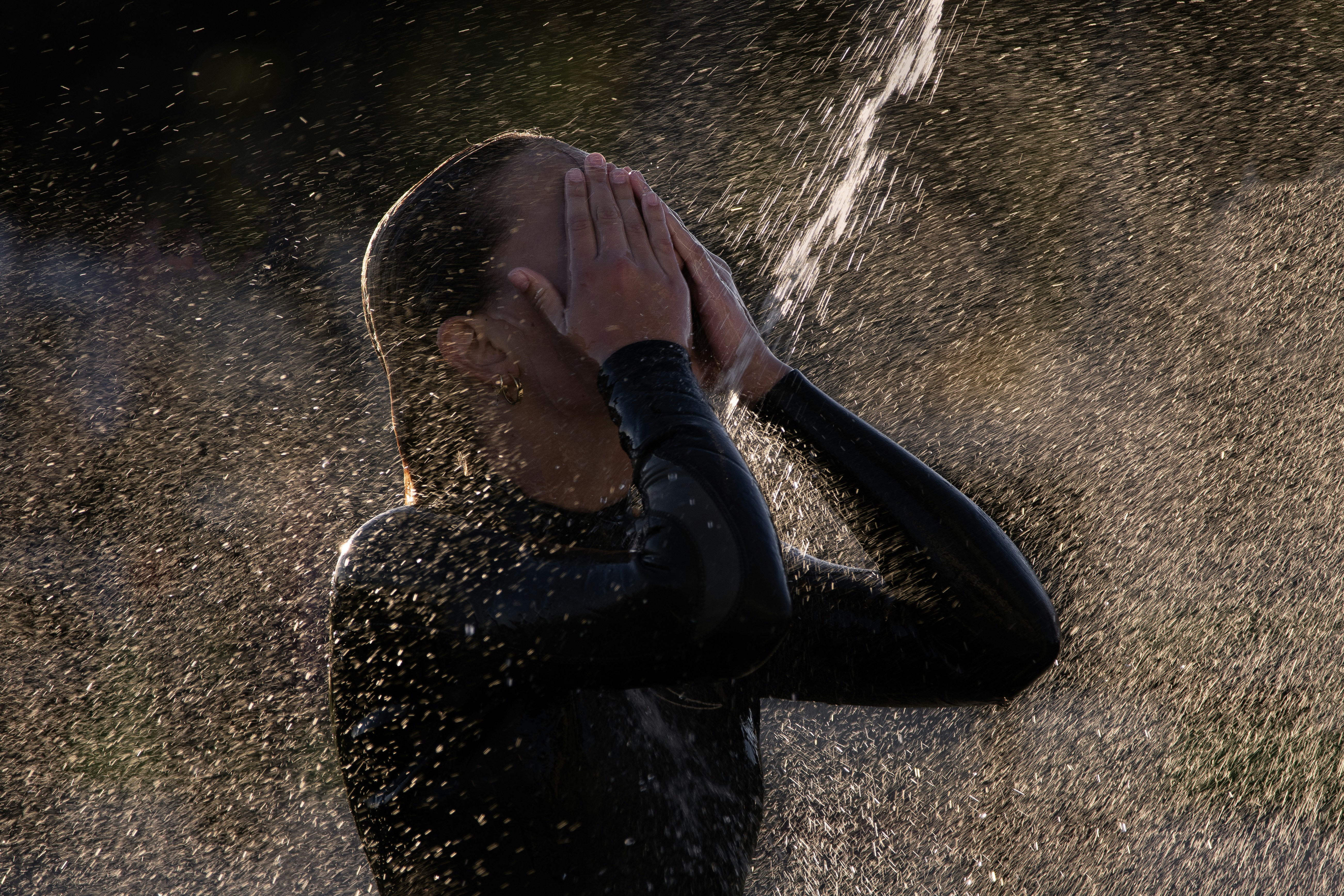 Shower of Spray: A Silhouette against a Backlit Water Curtain