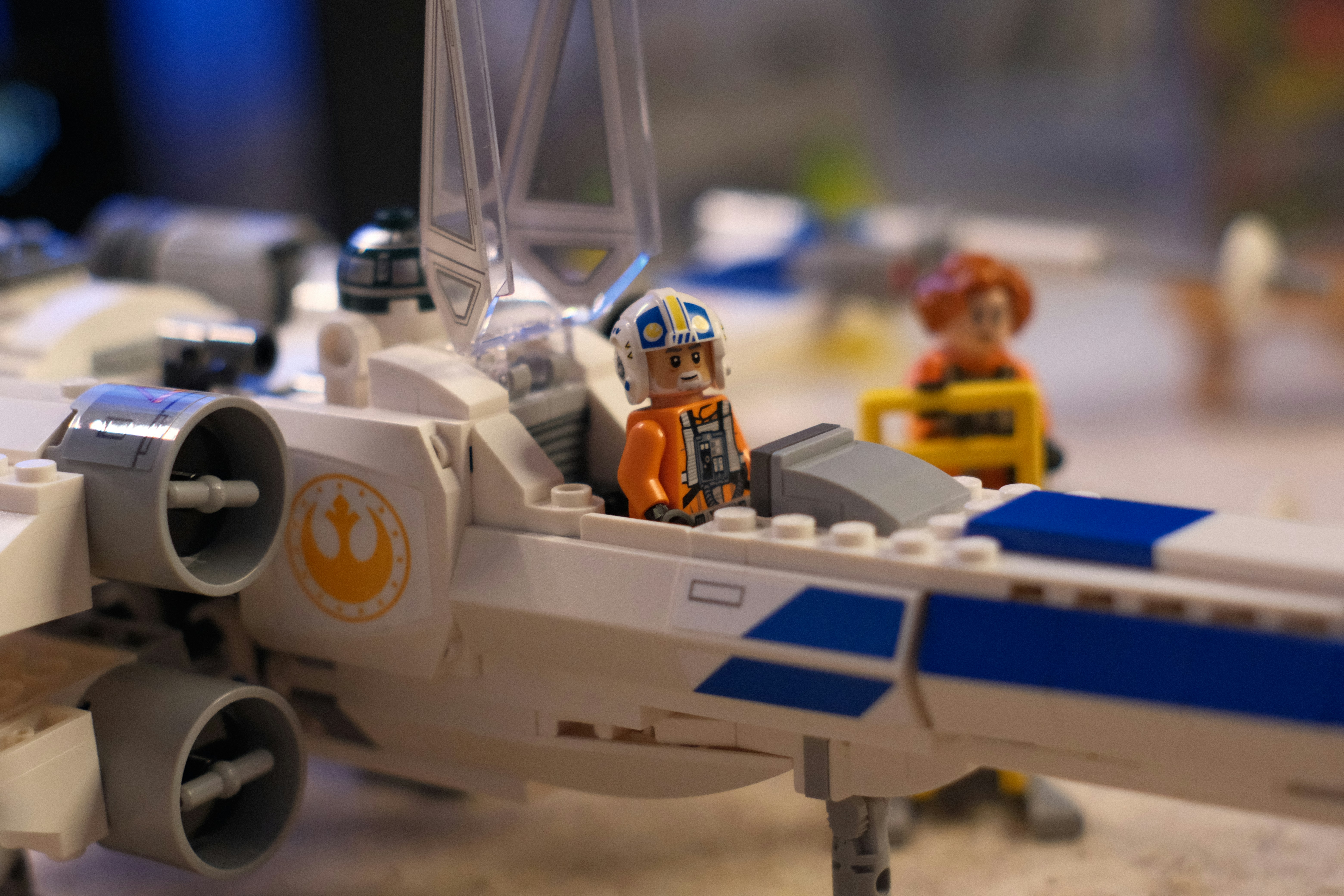 Lego Starfighter at Rest: Minifigure Pilot on a White-Blue Craft