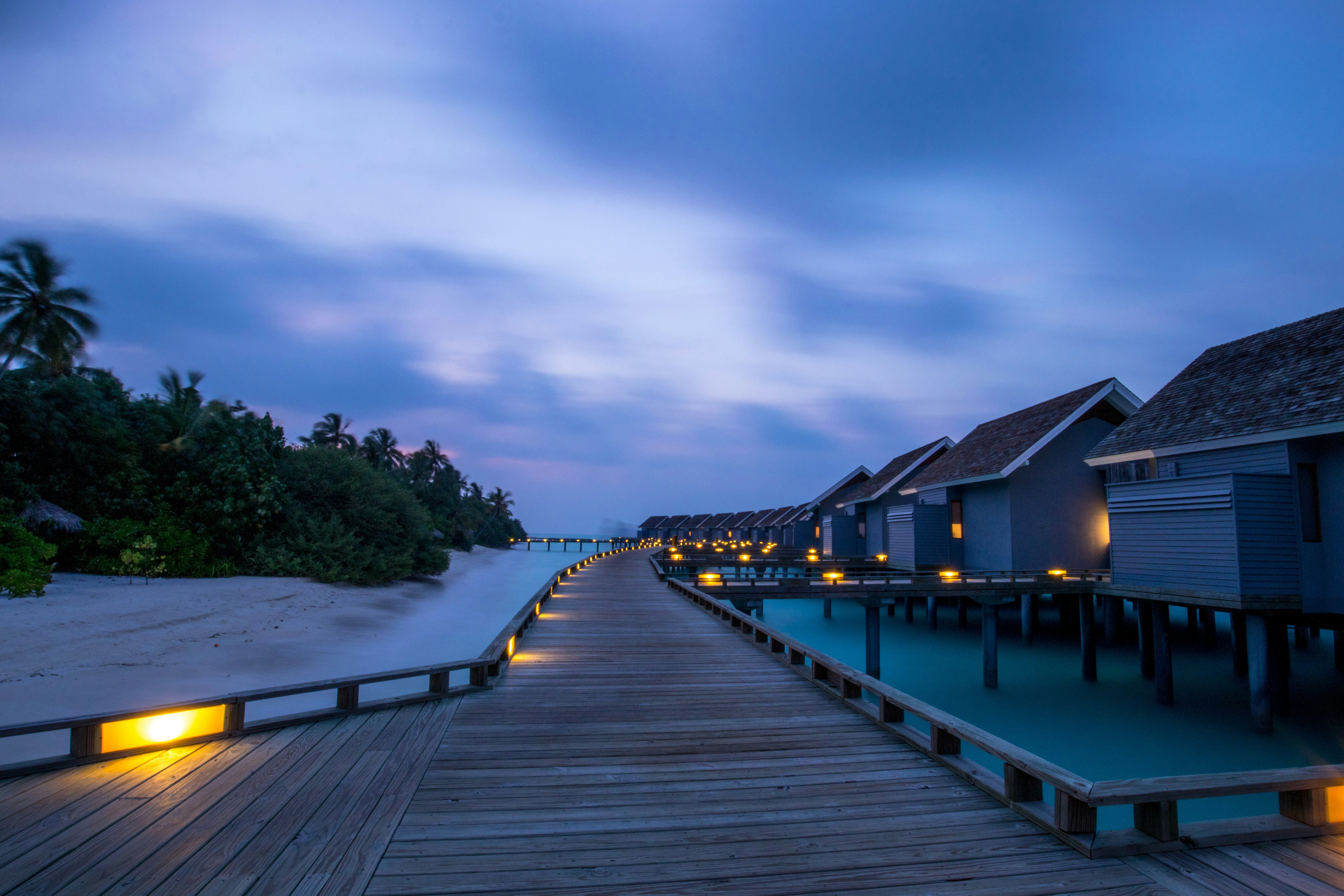 Moonlit Overwater Boardwalk to an Island of Lights