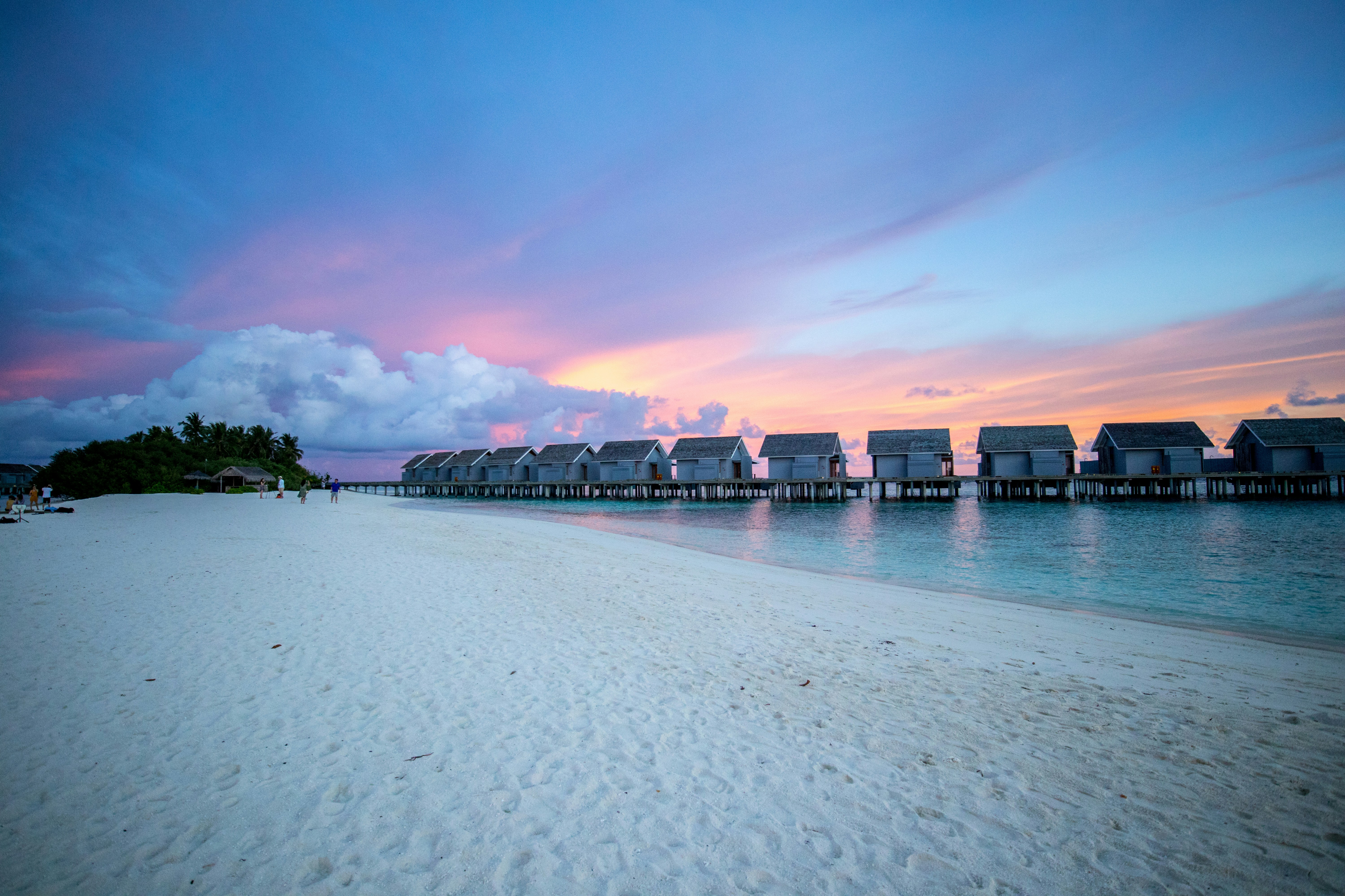 Pastel Horizon: Beach Bungalows Halt at Sunset