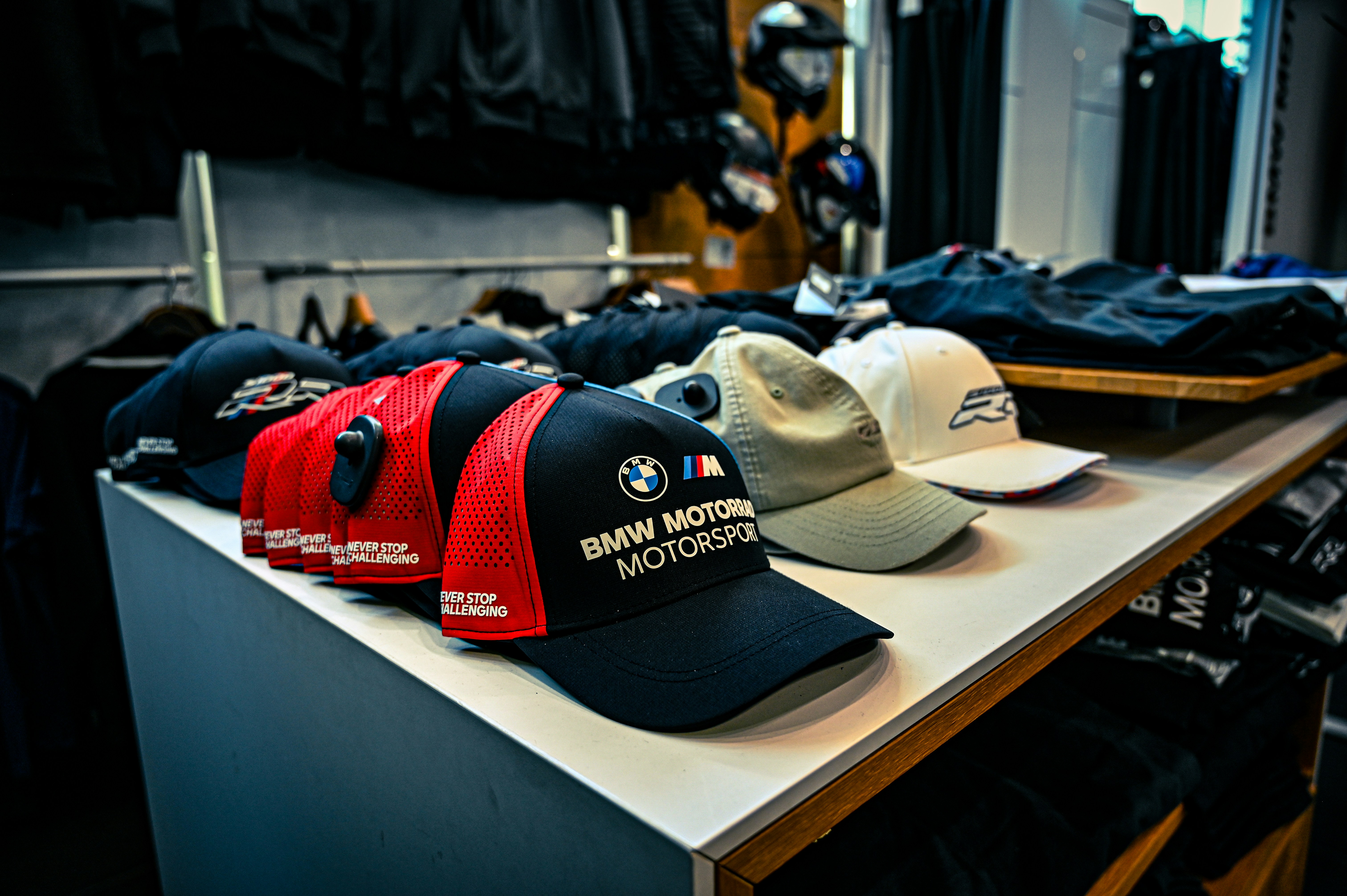 Row of branded caps on a retail display shelf