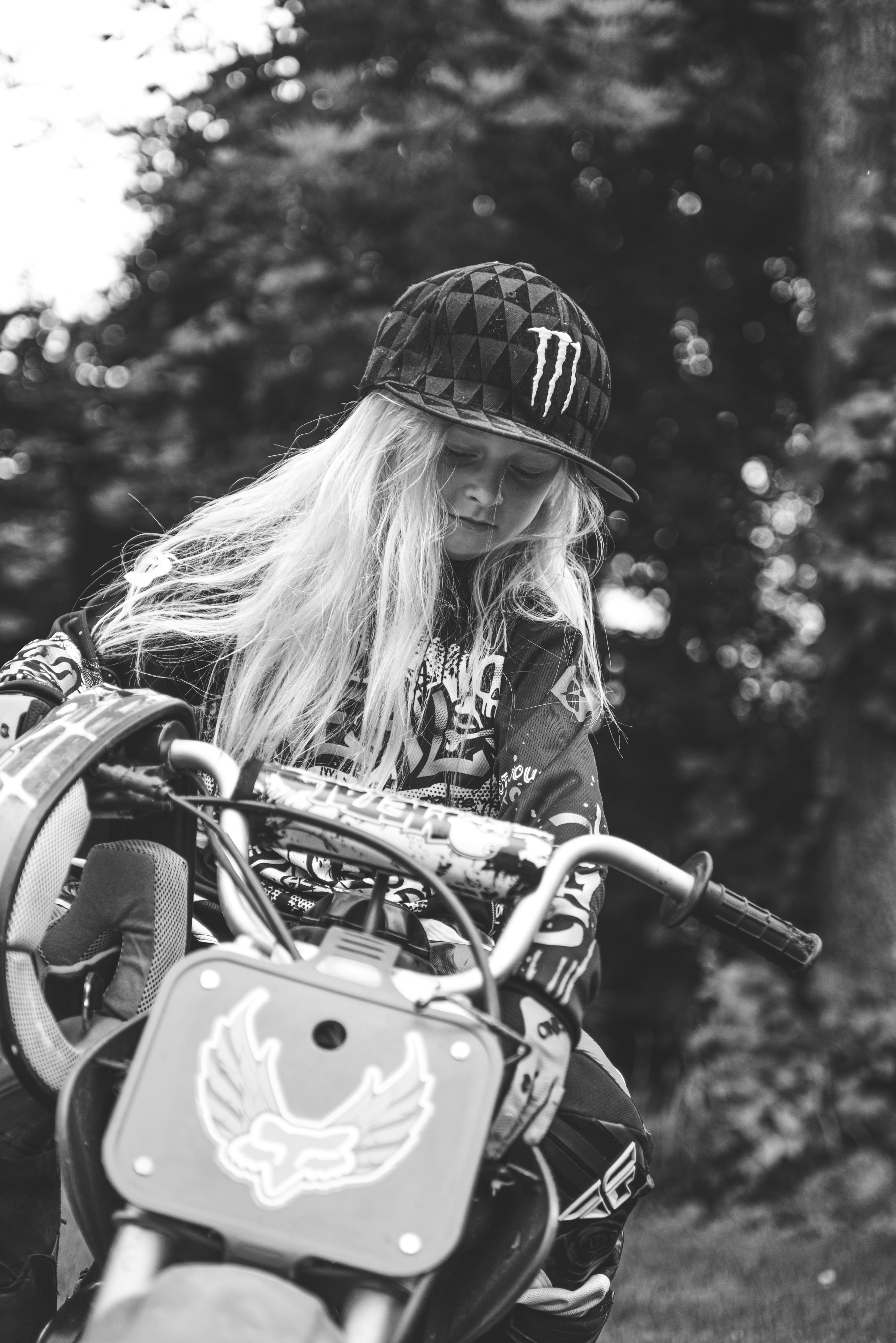 Youthful Rider with Monster Energy Hat Straddles a Dreamy Trail