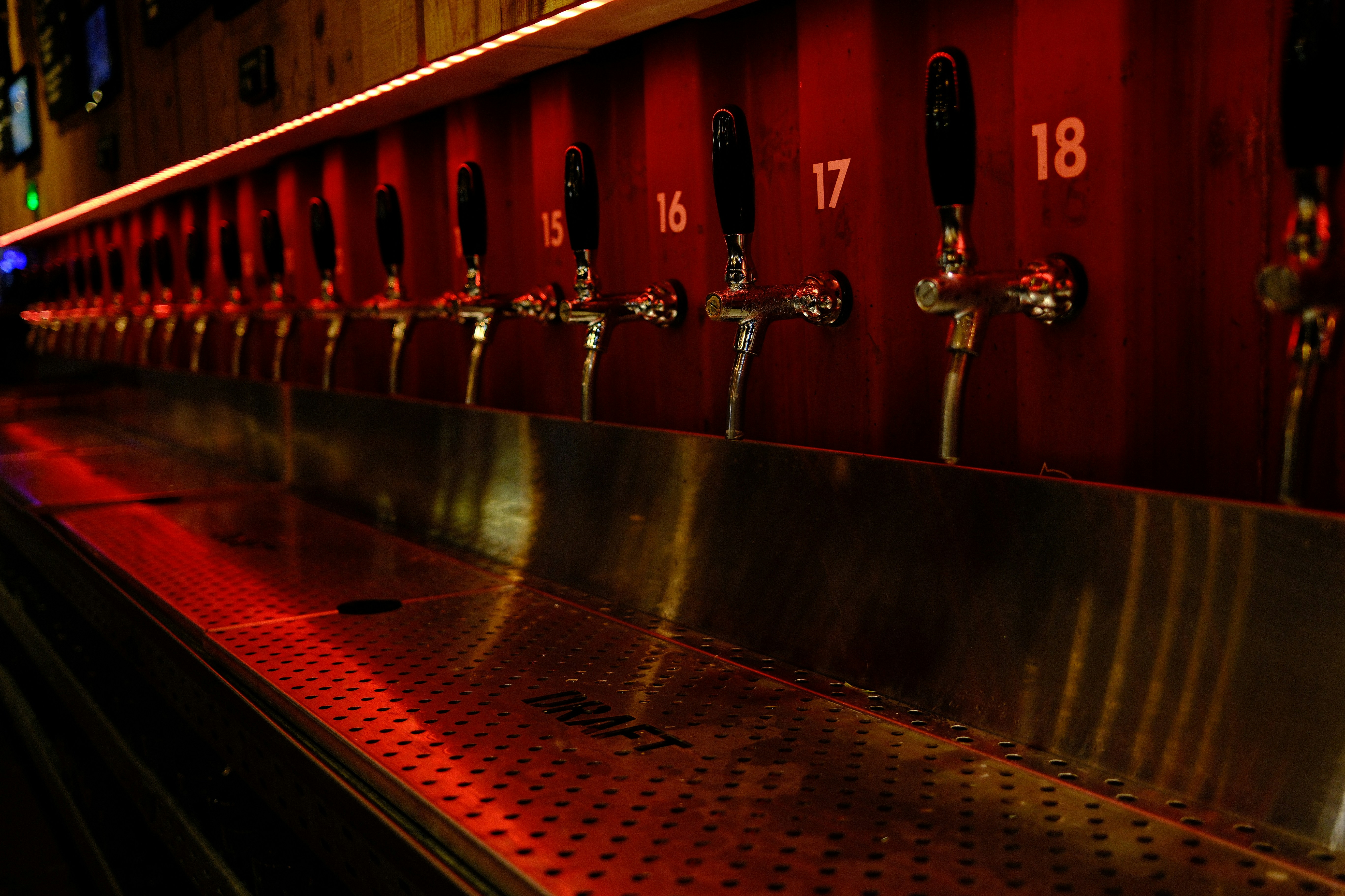Chrome Taps in a Crimson Draft Bar