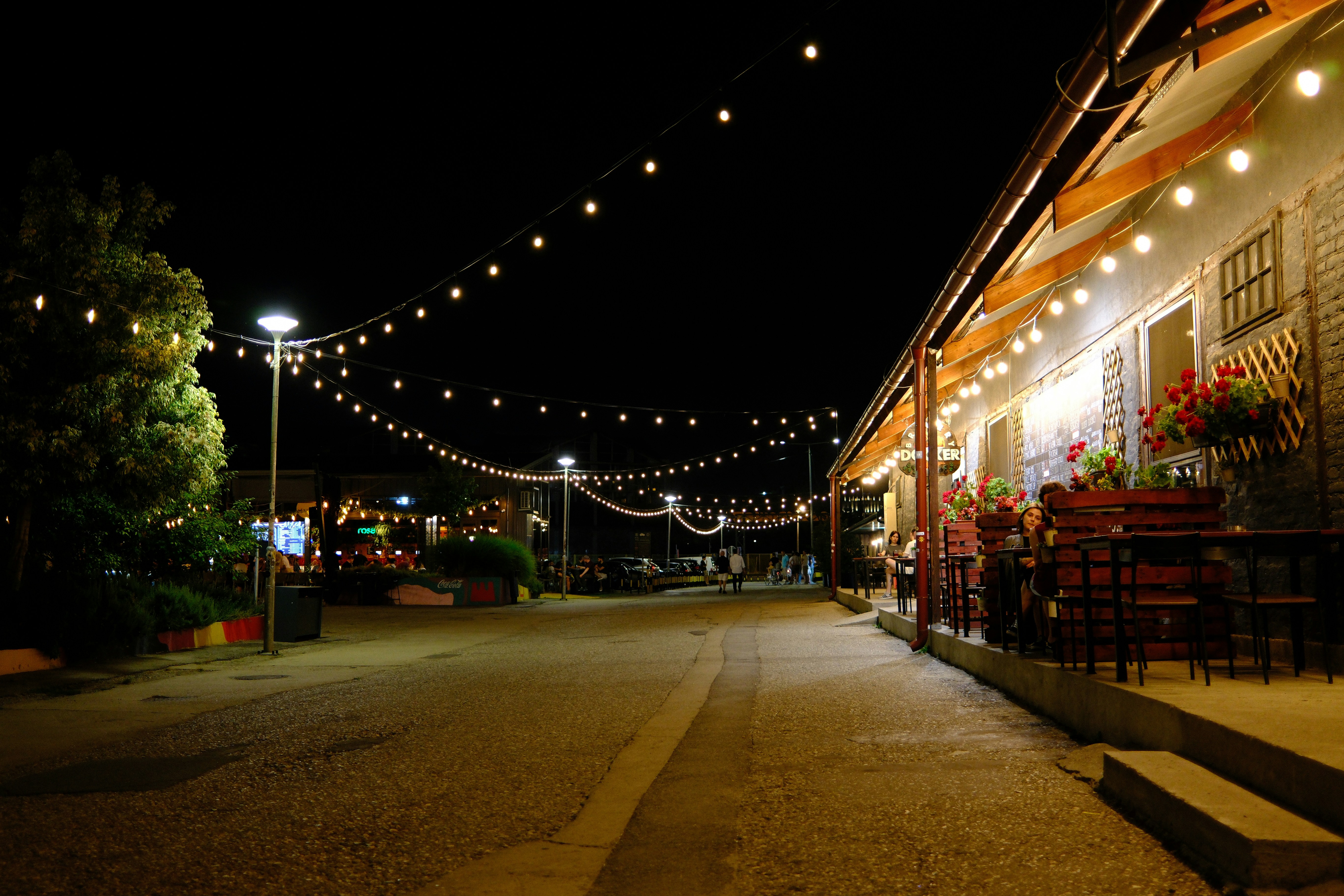Night Market Angel: Strings of Light Over a Quiet Village Lane