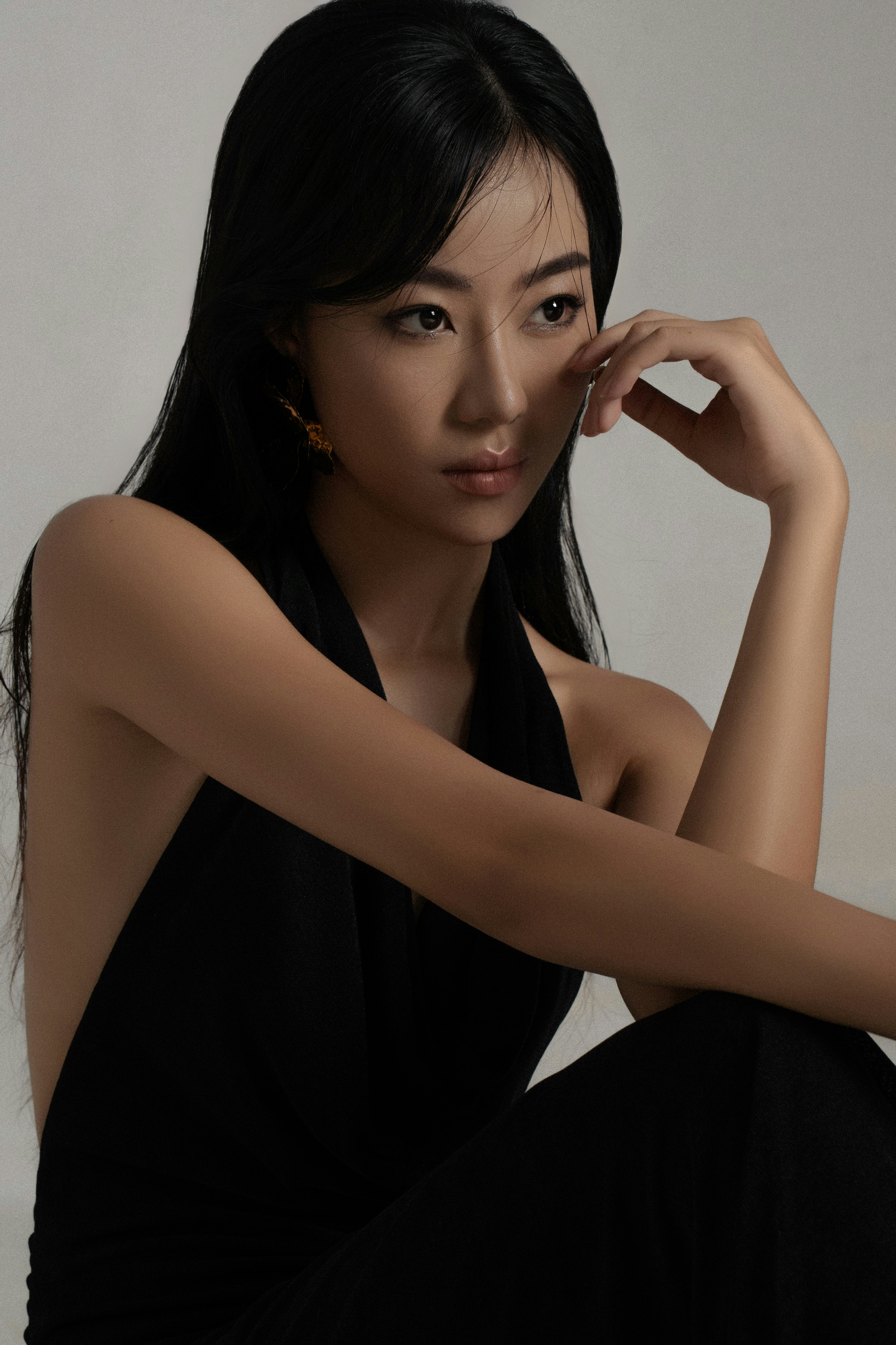 Glacial Grace: A Contemplative Studio Portrait in Velvet Black