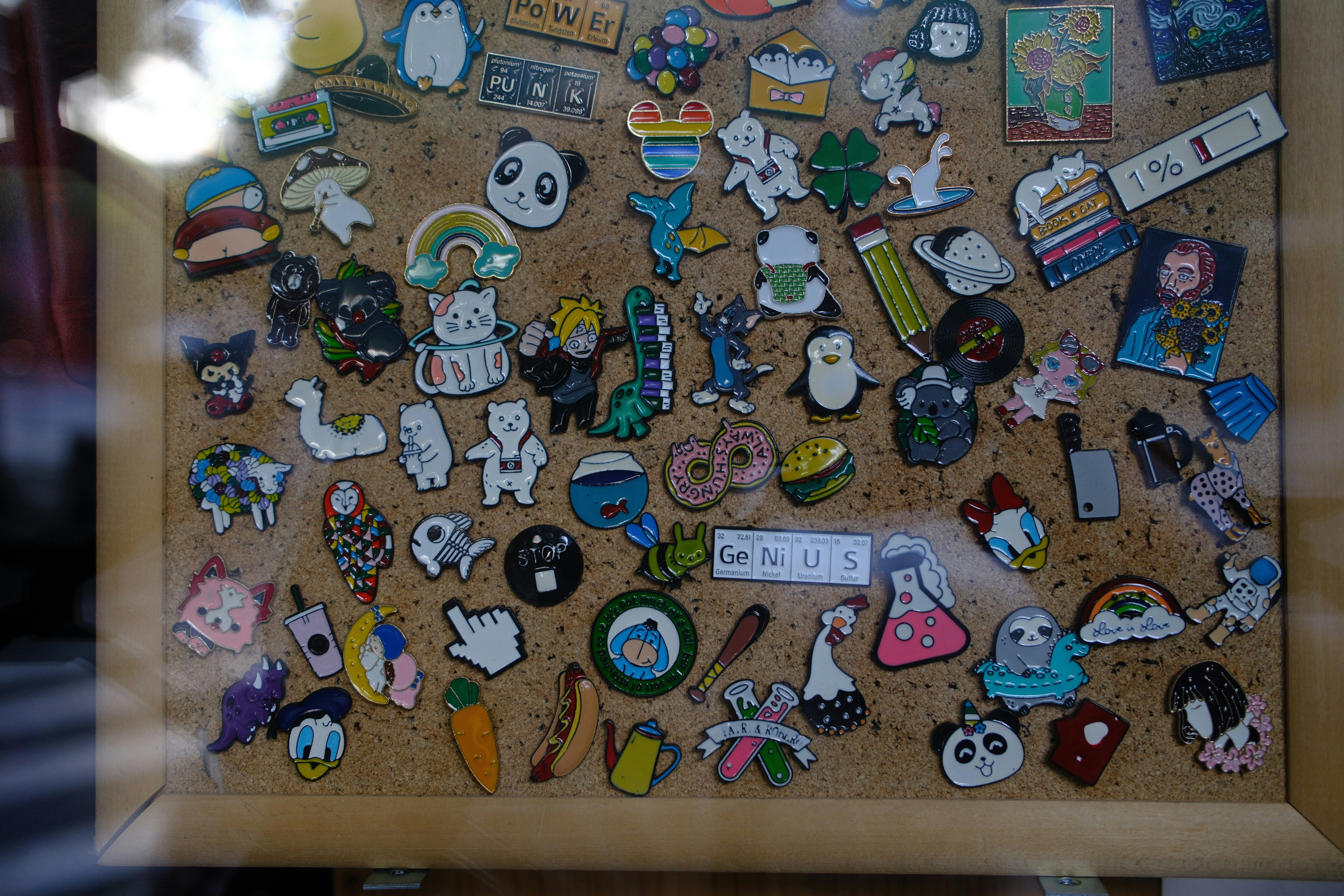 Sticker Mosaic: A corkboard full of colorful pins and doodads