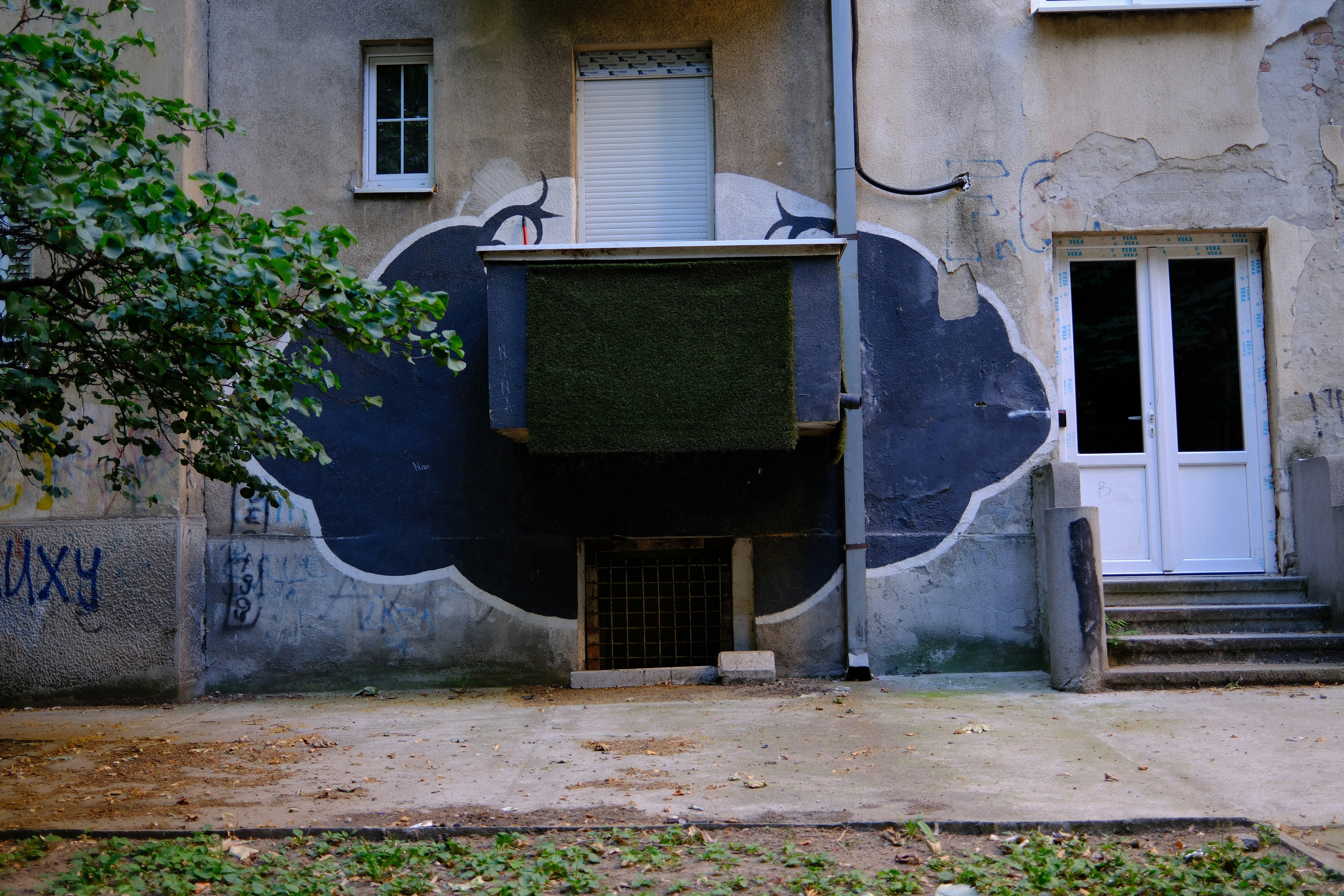Graffiti Alcove: A Facade Painted Cloud Over a Quiet Doorway