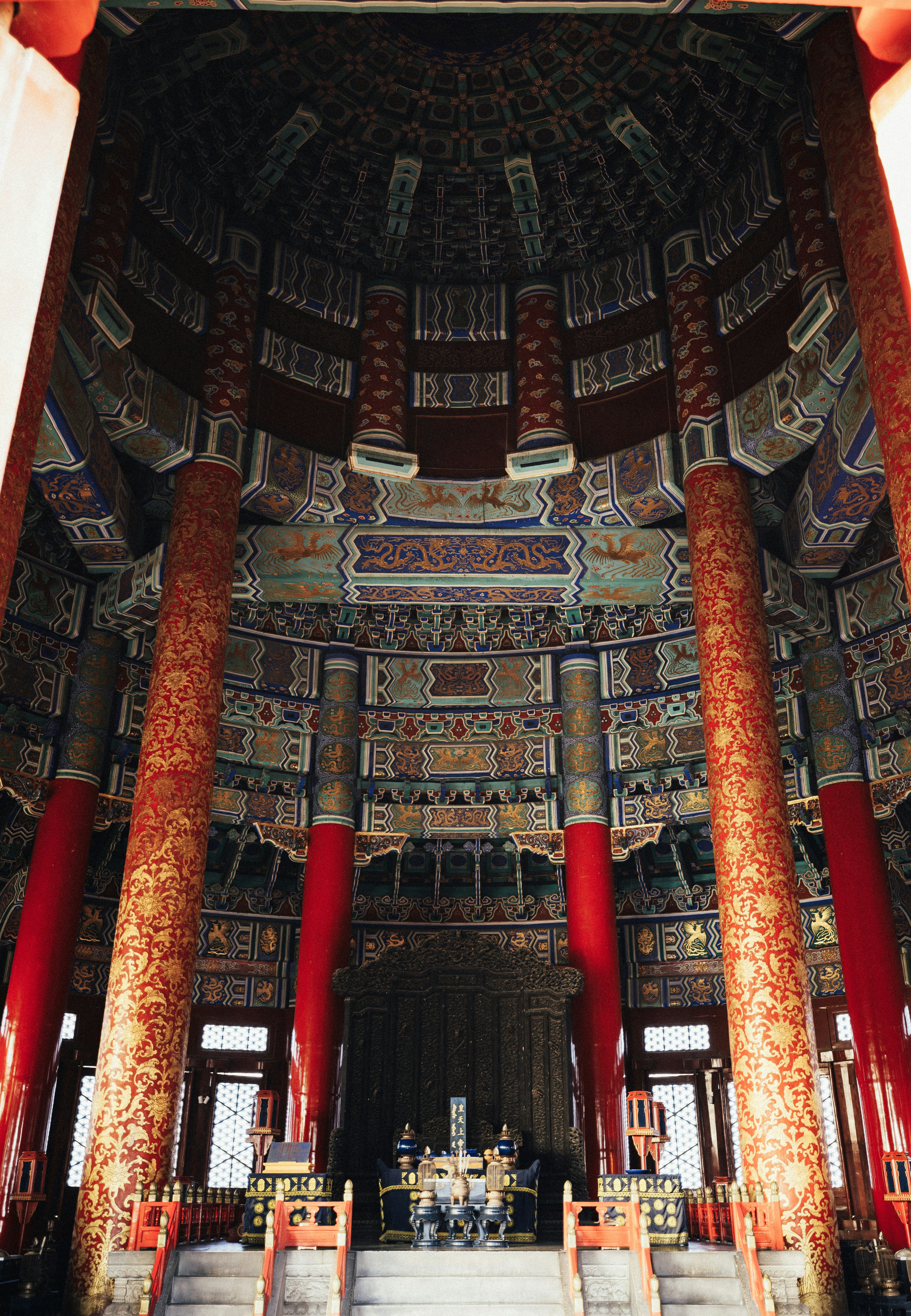 Red Columns and Ornate Ceiling: A Gateway to Ancient Craft