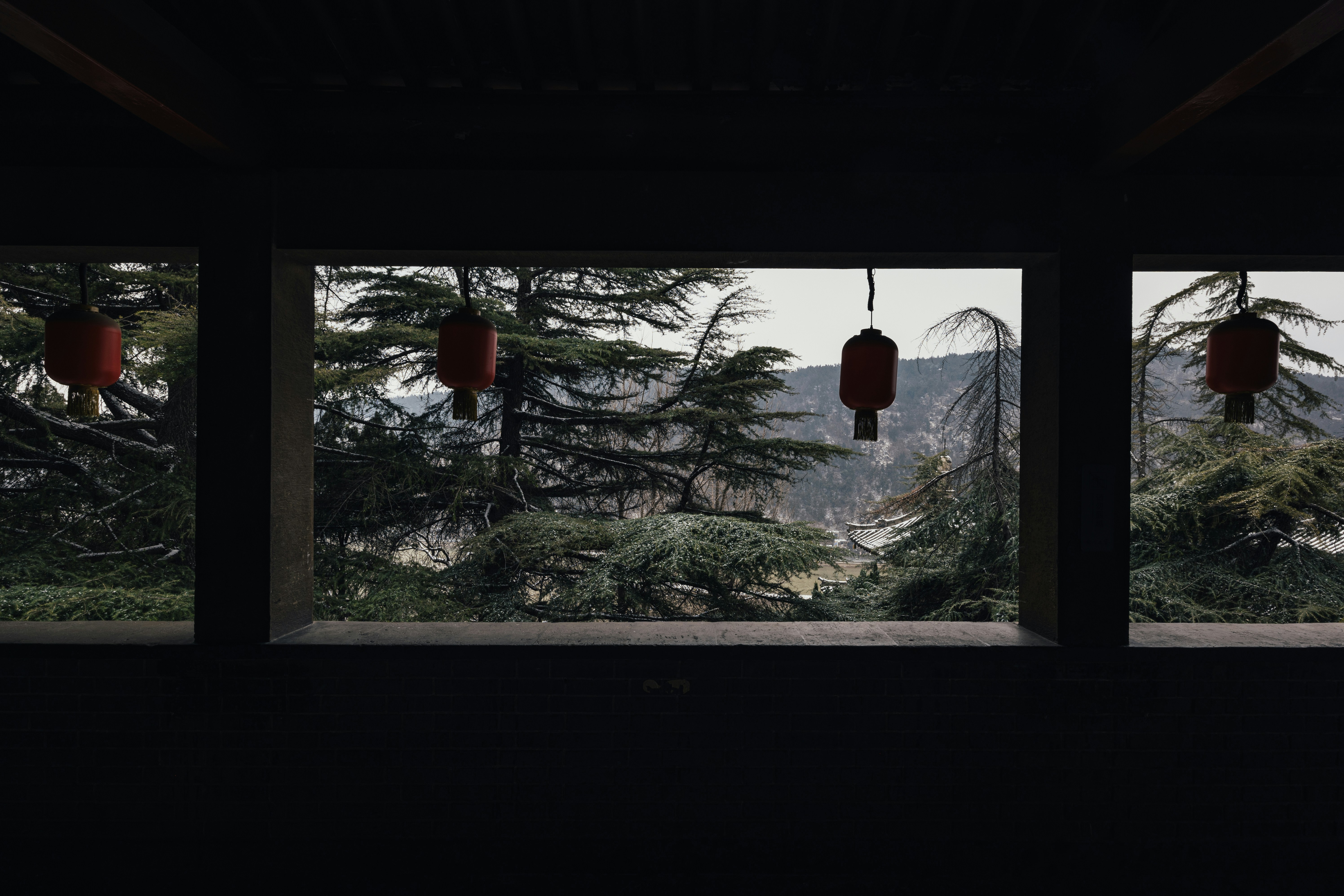Framed Horizon: Lanterns Against a Mountain Veil