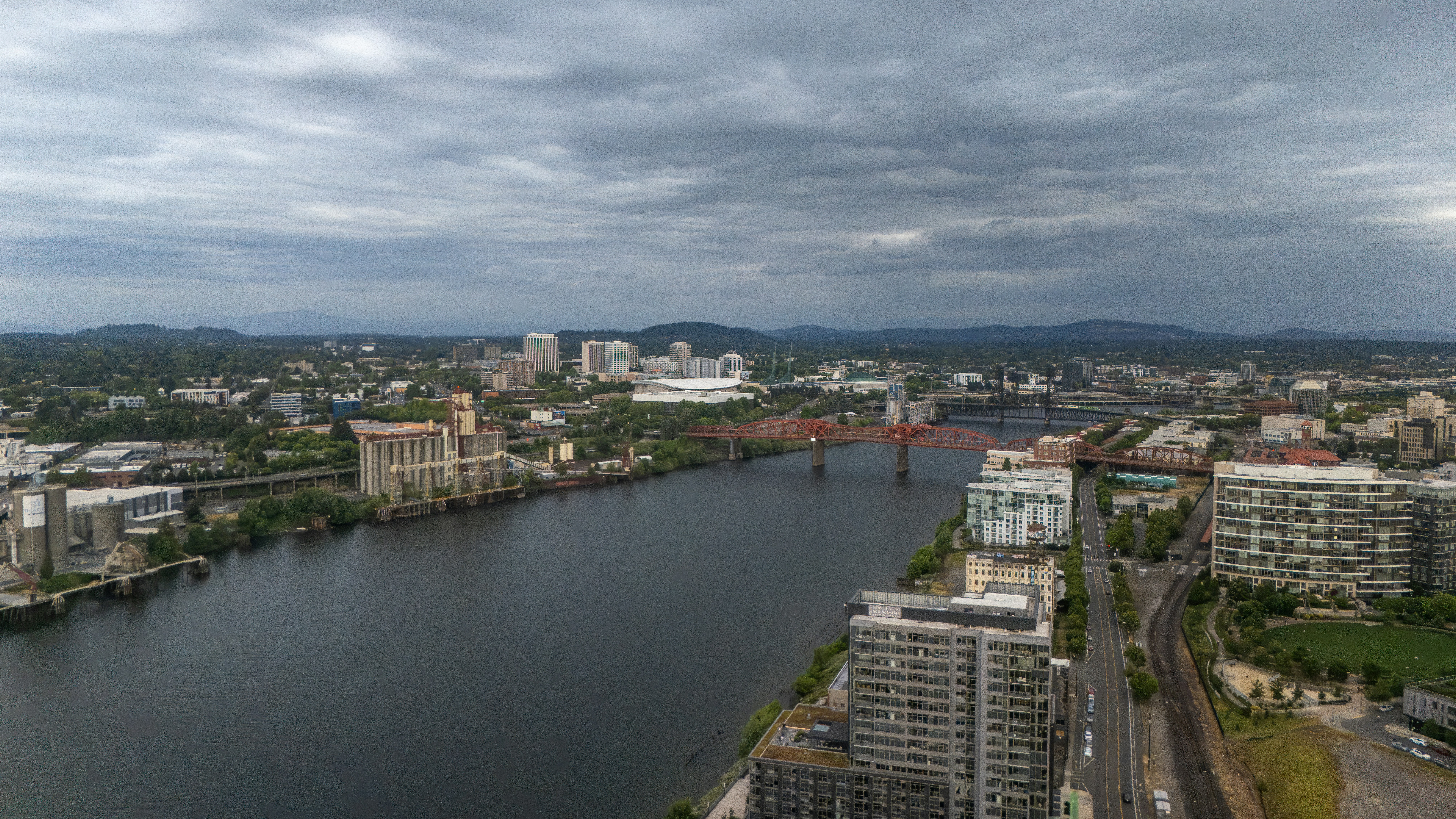 City on the Riverside: Urban Spine under a Brooding Sky
