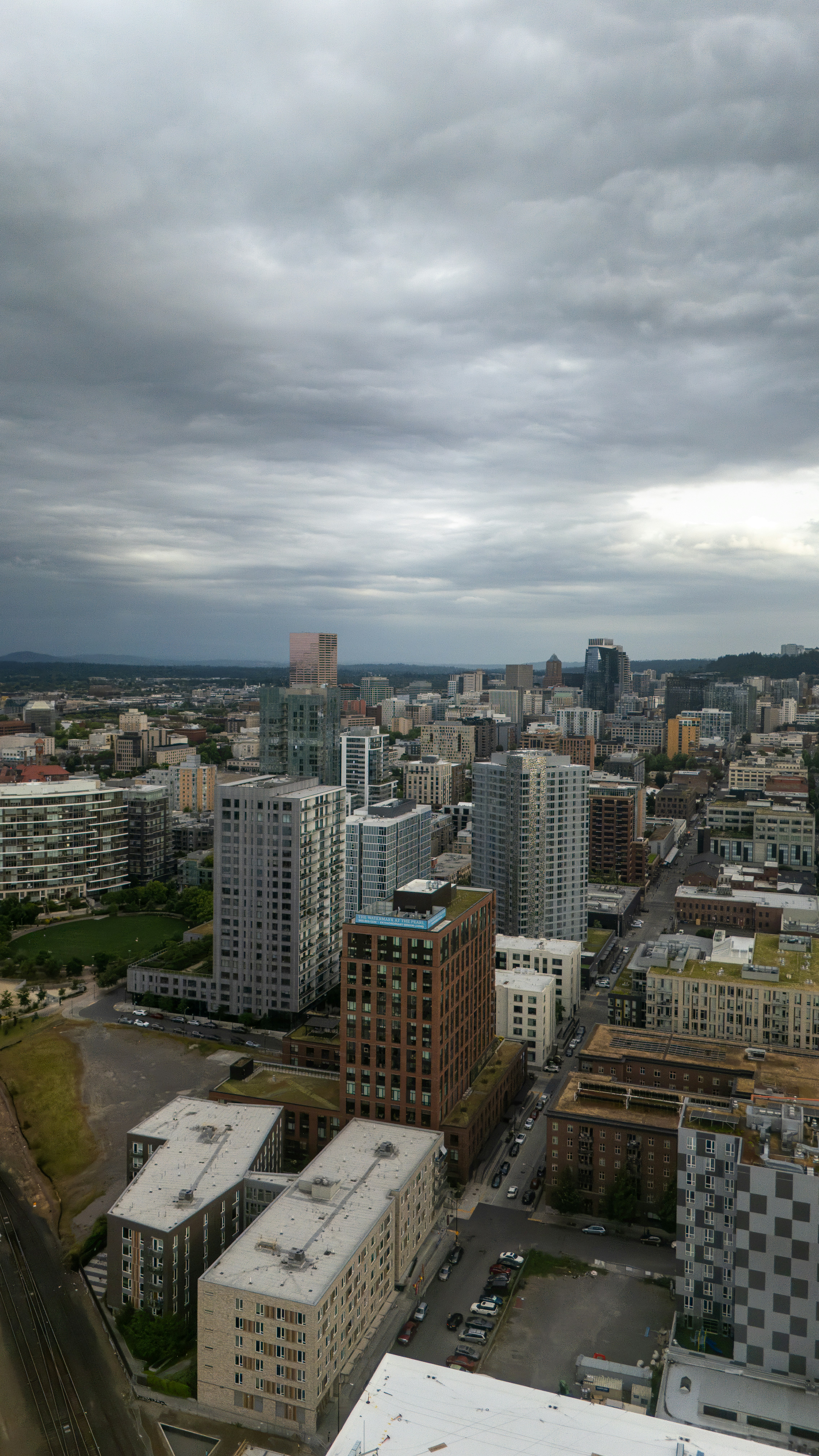 Midday Rain Over the Riverside Grid: A Cityscape Panorama