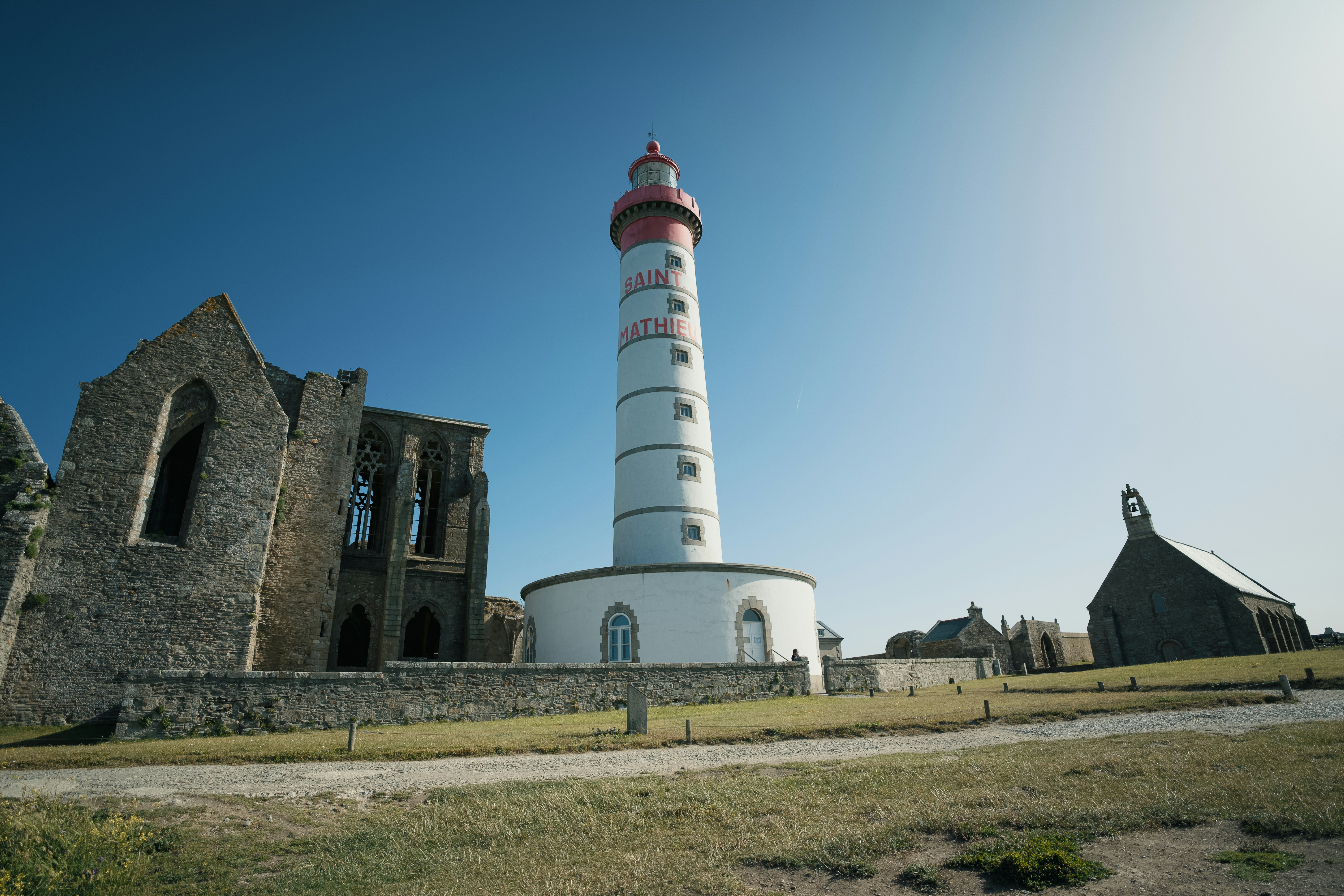 Lighthouse Sentinel: A Whimsical Coastline with Ruined Cloisters