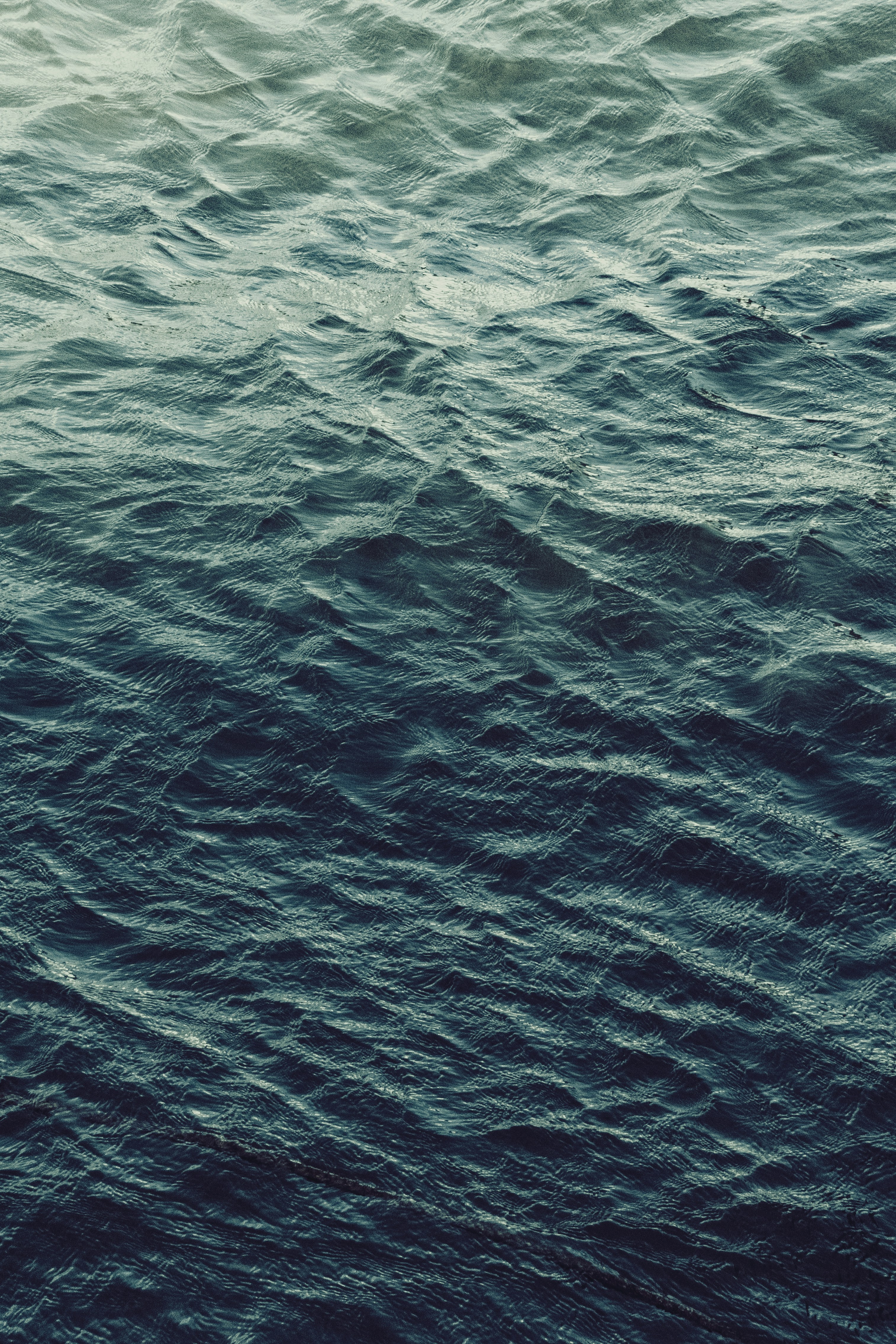 Oceanic Texture: Moonlit Ripples Across a Sable Sea