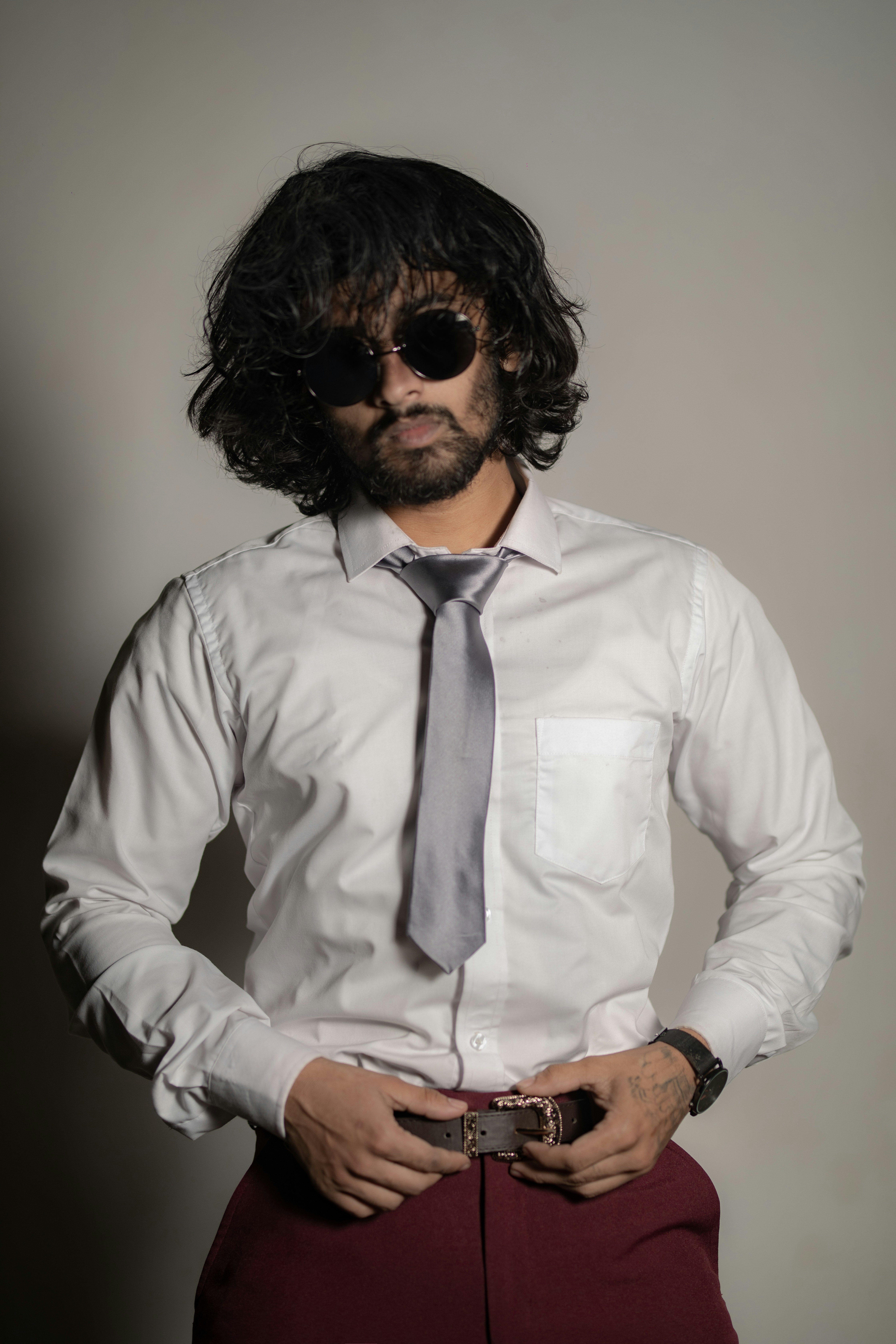 Shadowed Style: A Portrait of Confidence in White and Bloom