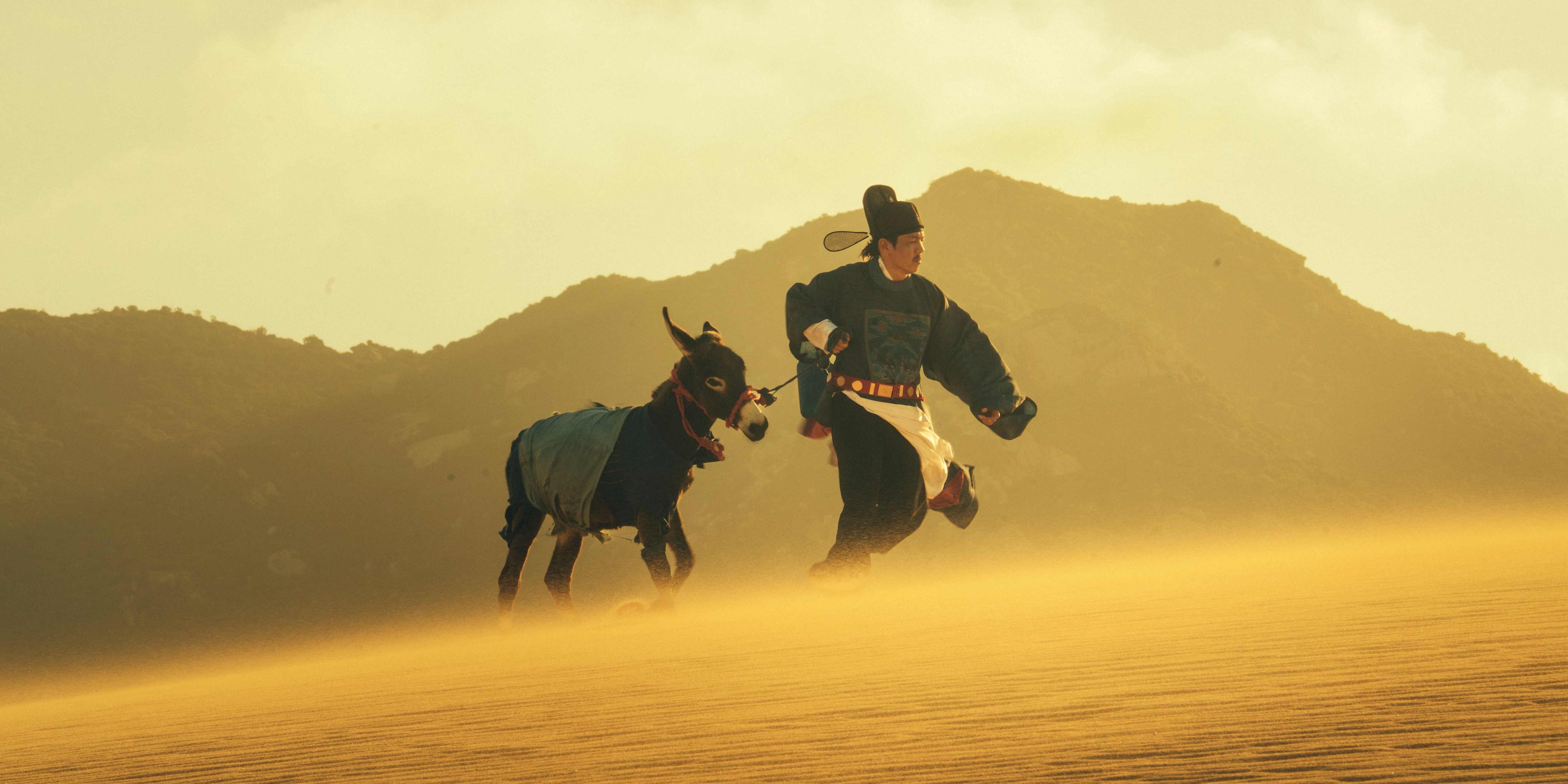 Runners with a Dragon-Headed Companion Across a Golden Dune