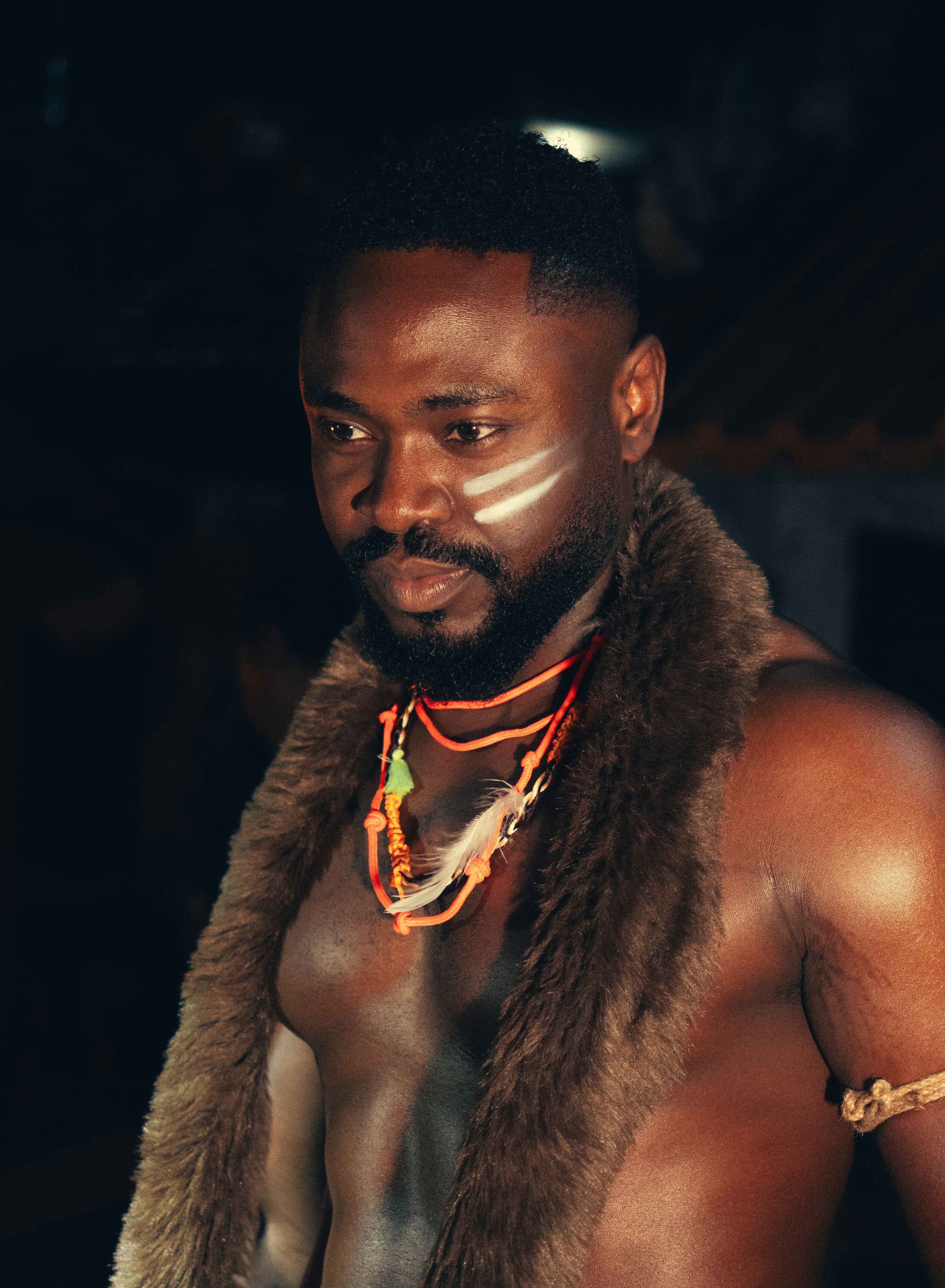 Face Under Tribal Glow: A Portrait in Low Light