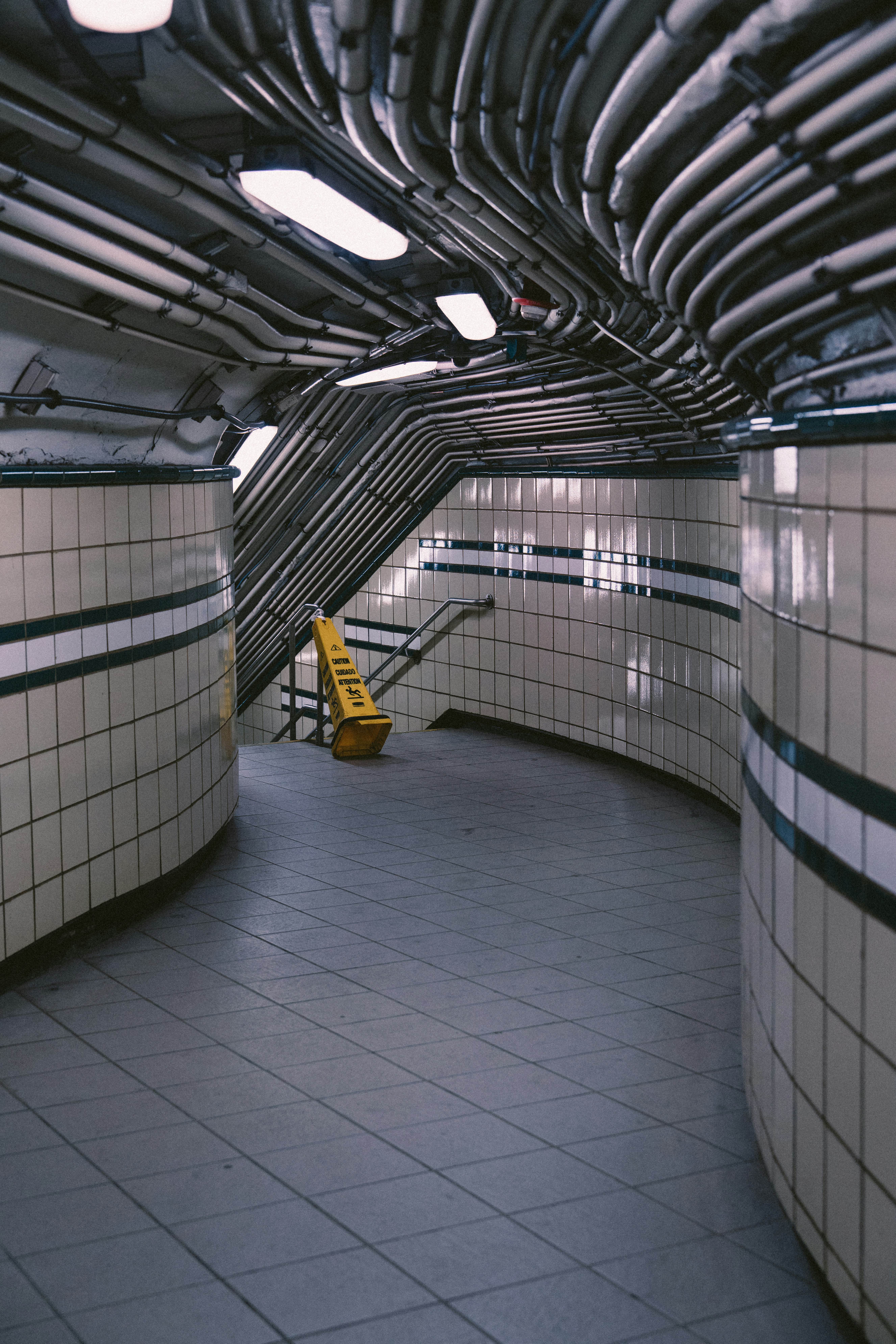 Curved Subway Corridor: A Quiet Descent Through Tile and Steel