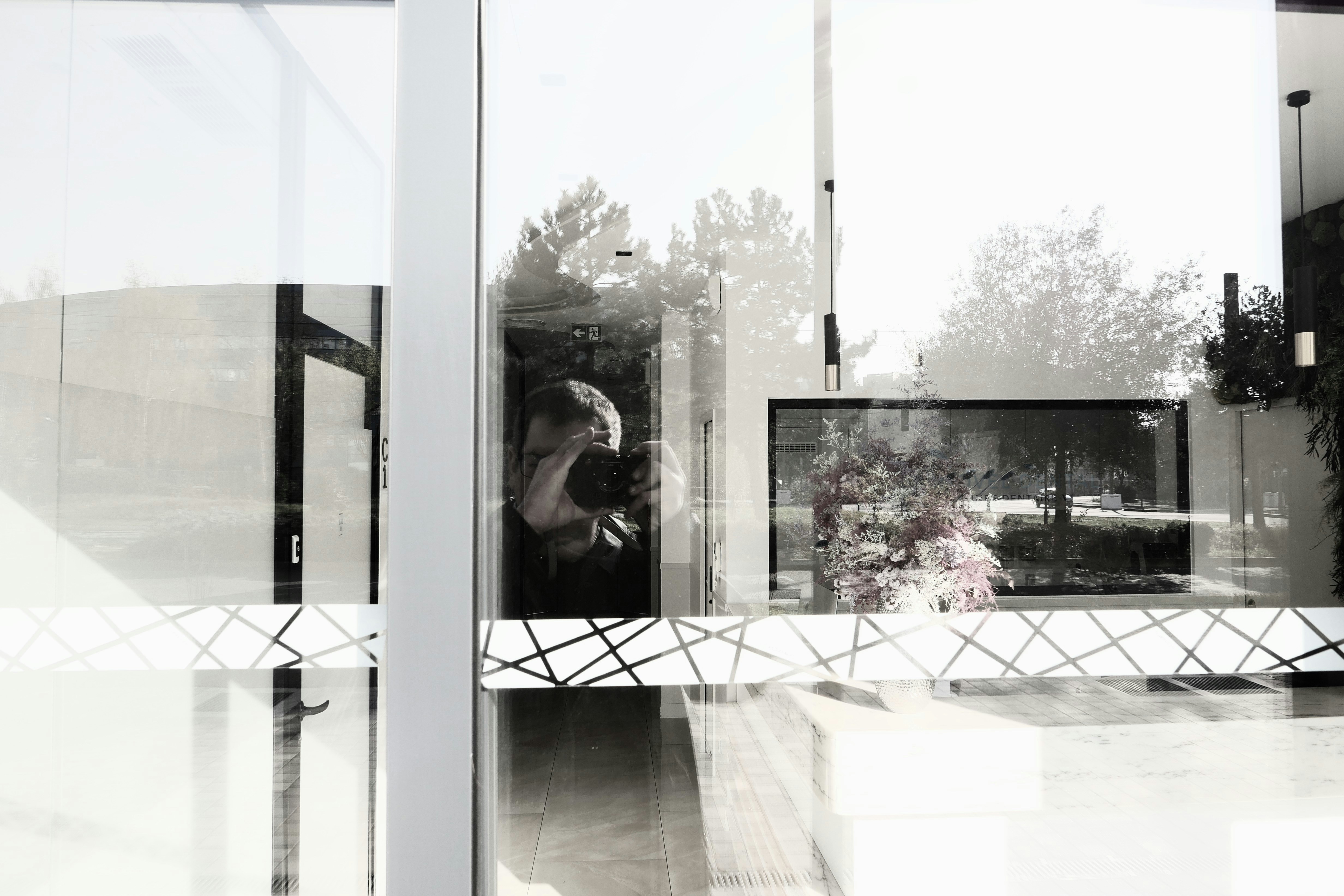 Reflections at the Threshold: Glass Facade Echoes a Quiet Landscape