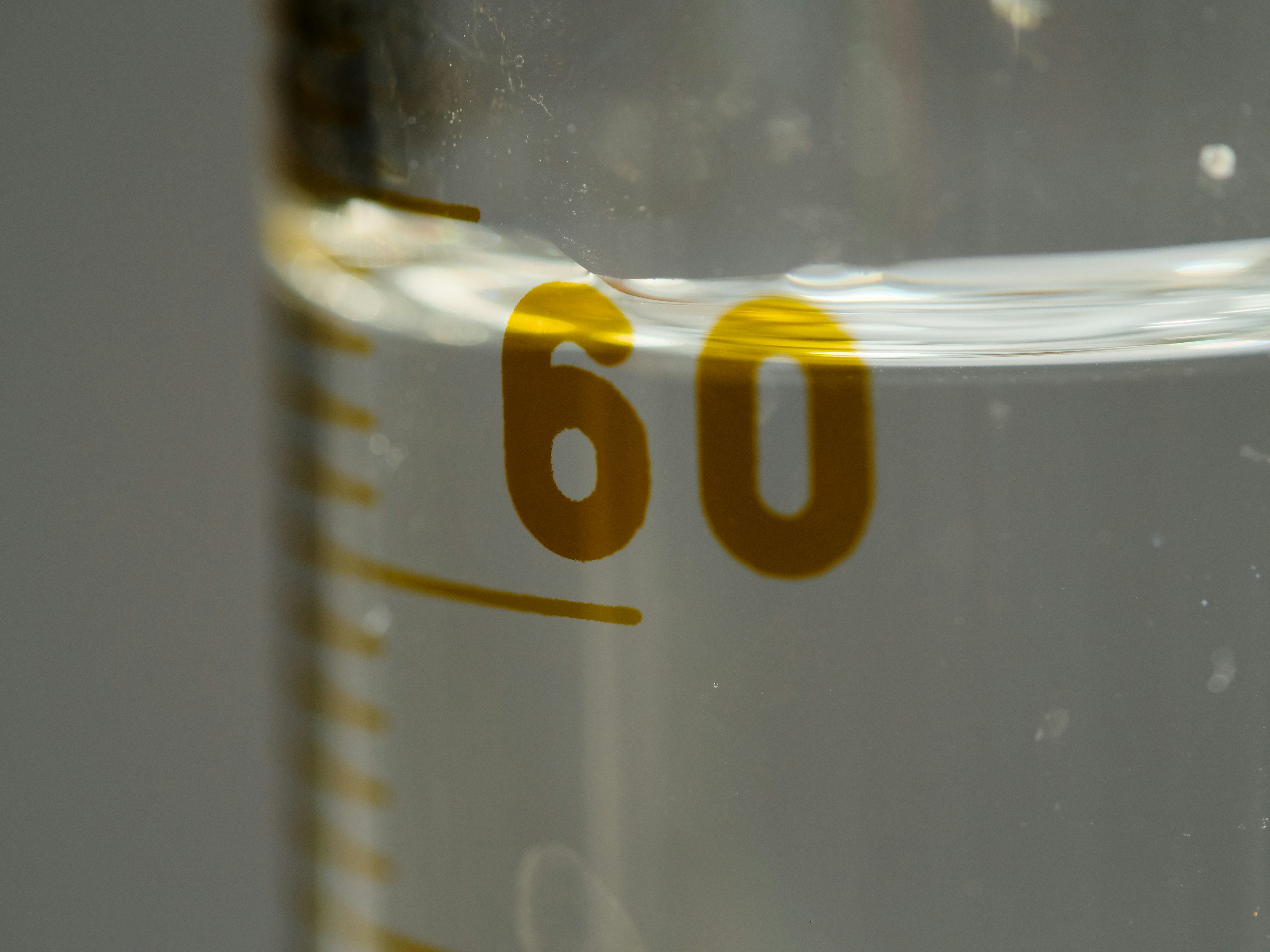 Golden 60: A Close-Up of Liquid Measure Amidst Soft Focus