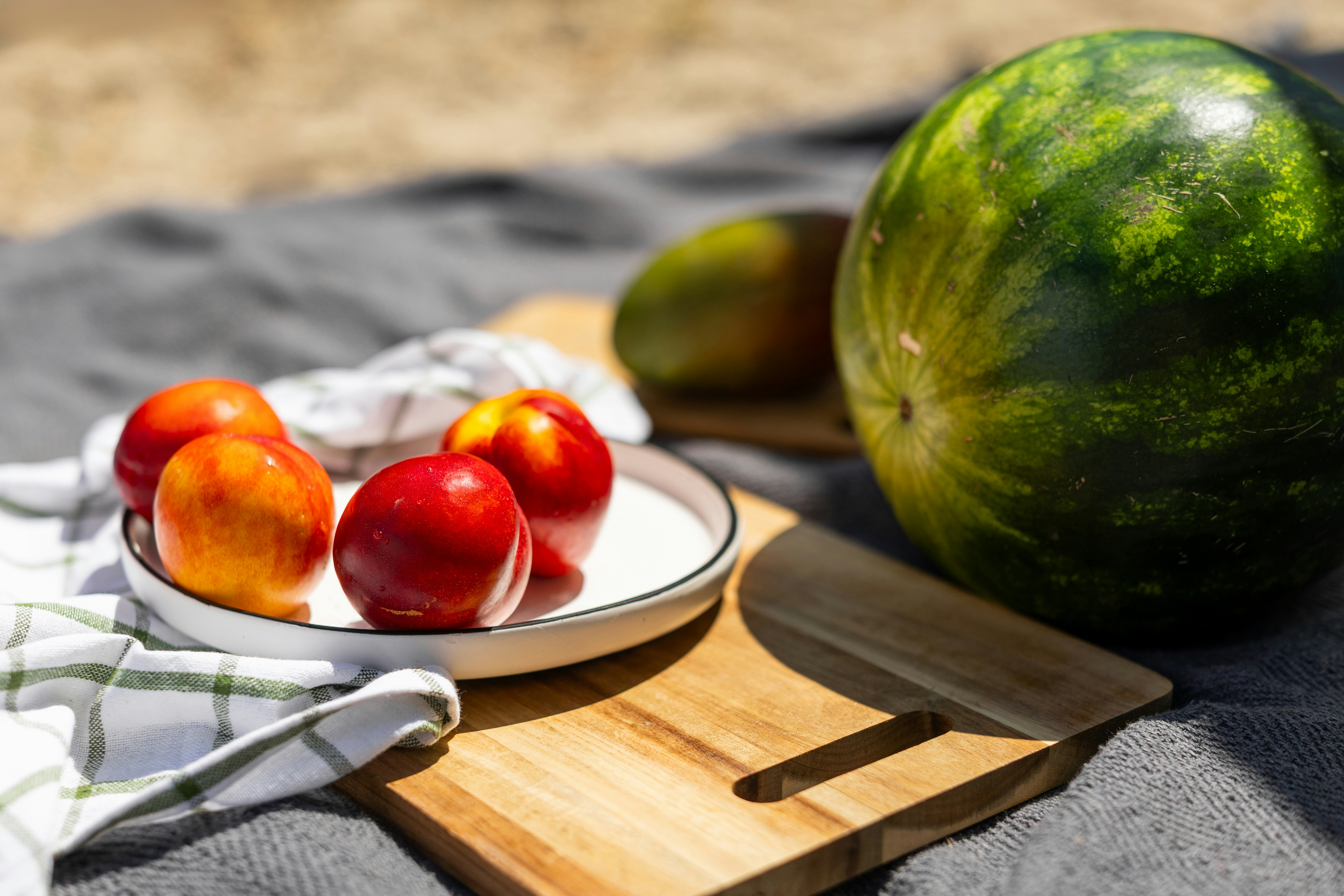 Peaches meet watermelon: a rustic still life on a sunlit chopping board