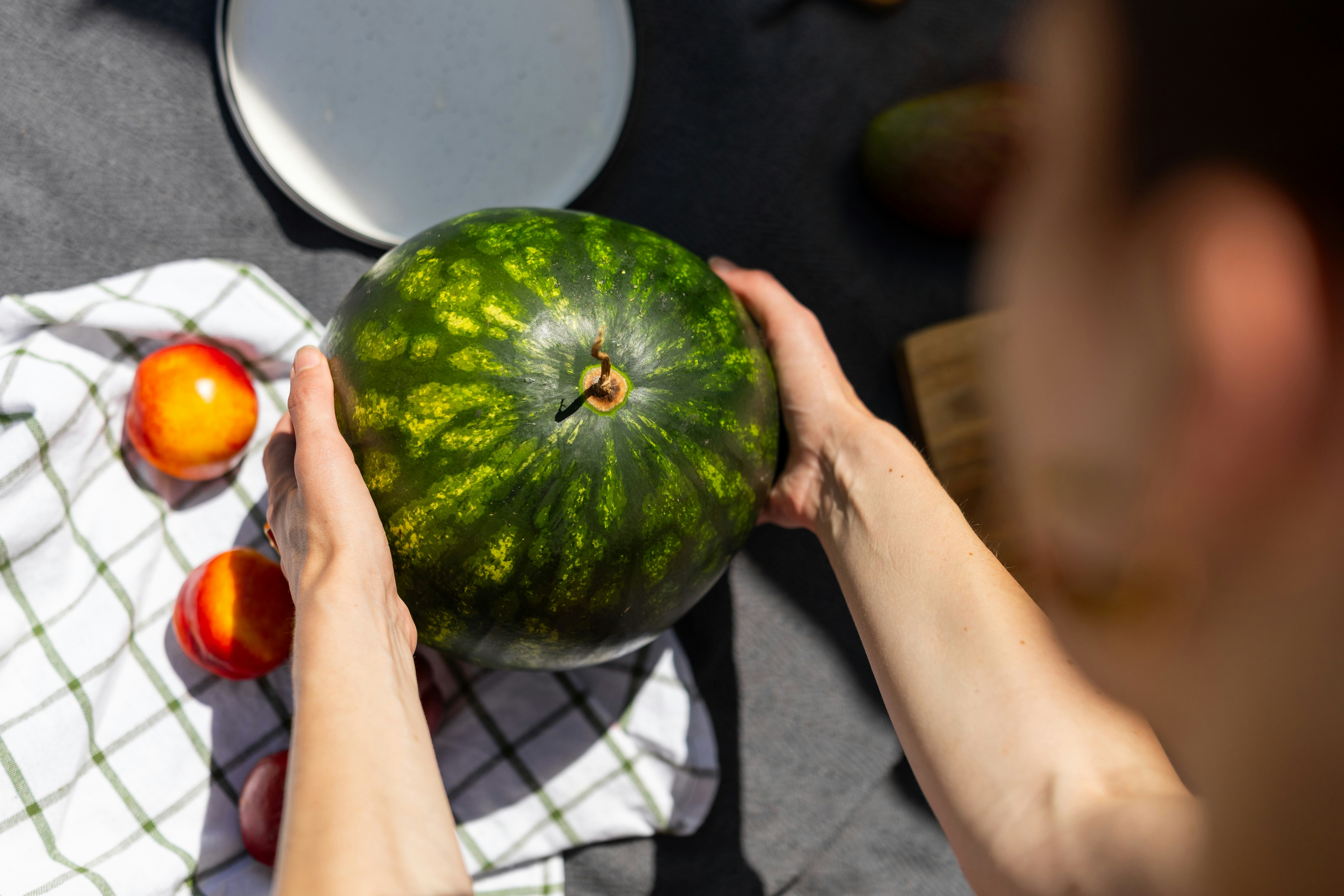 Hands Steady over a Watermelon: A Fresh Market Moment